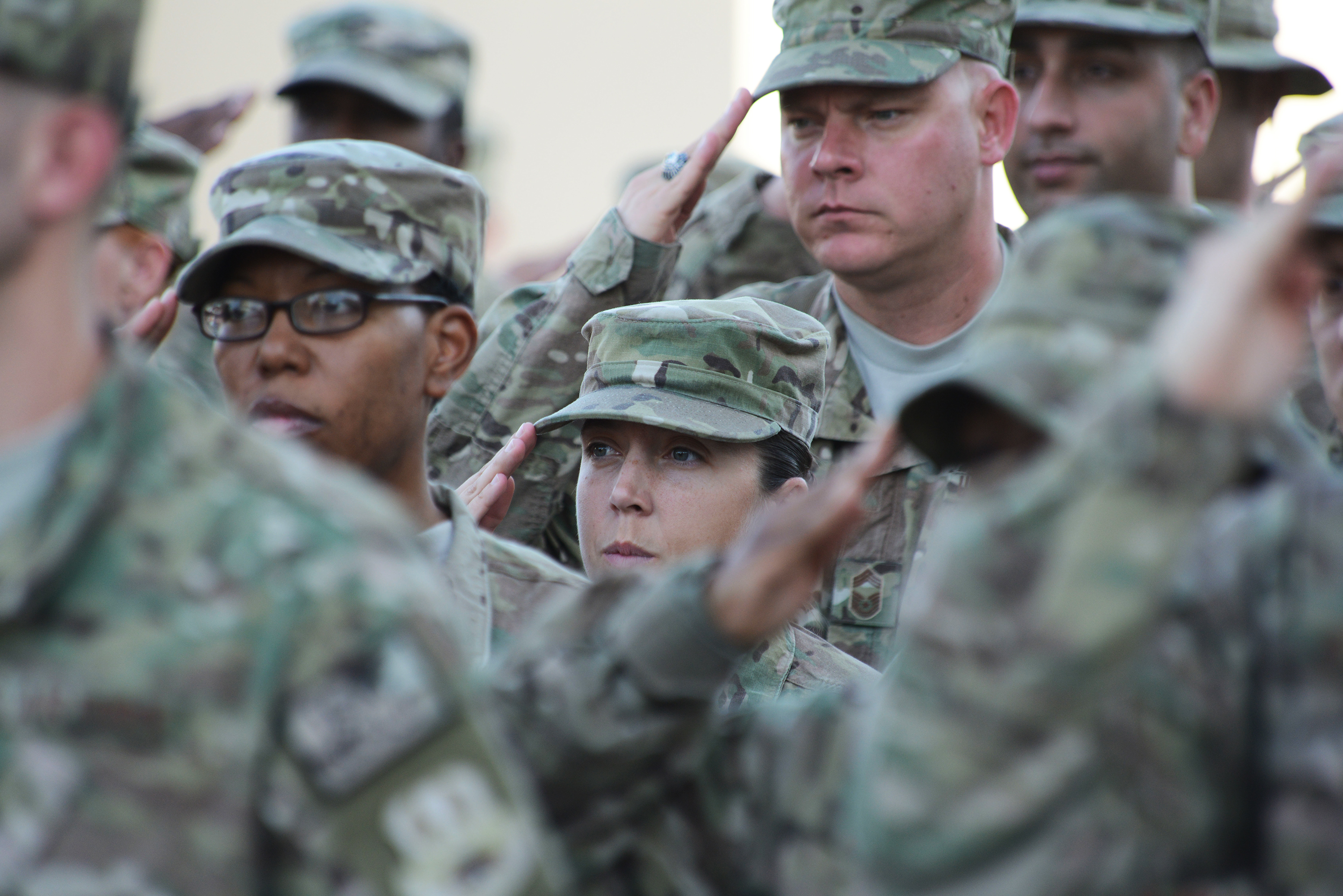 U.S. Air Force airmen salute during a retreat and re-enlistment ...
