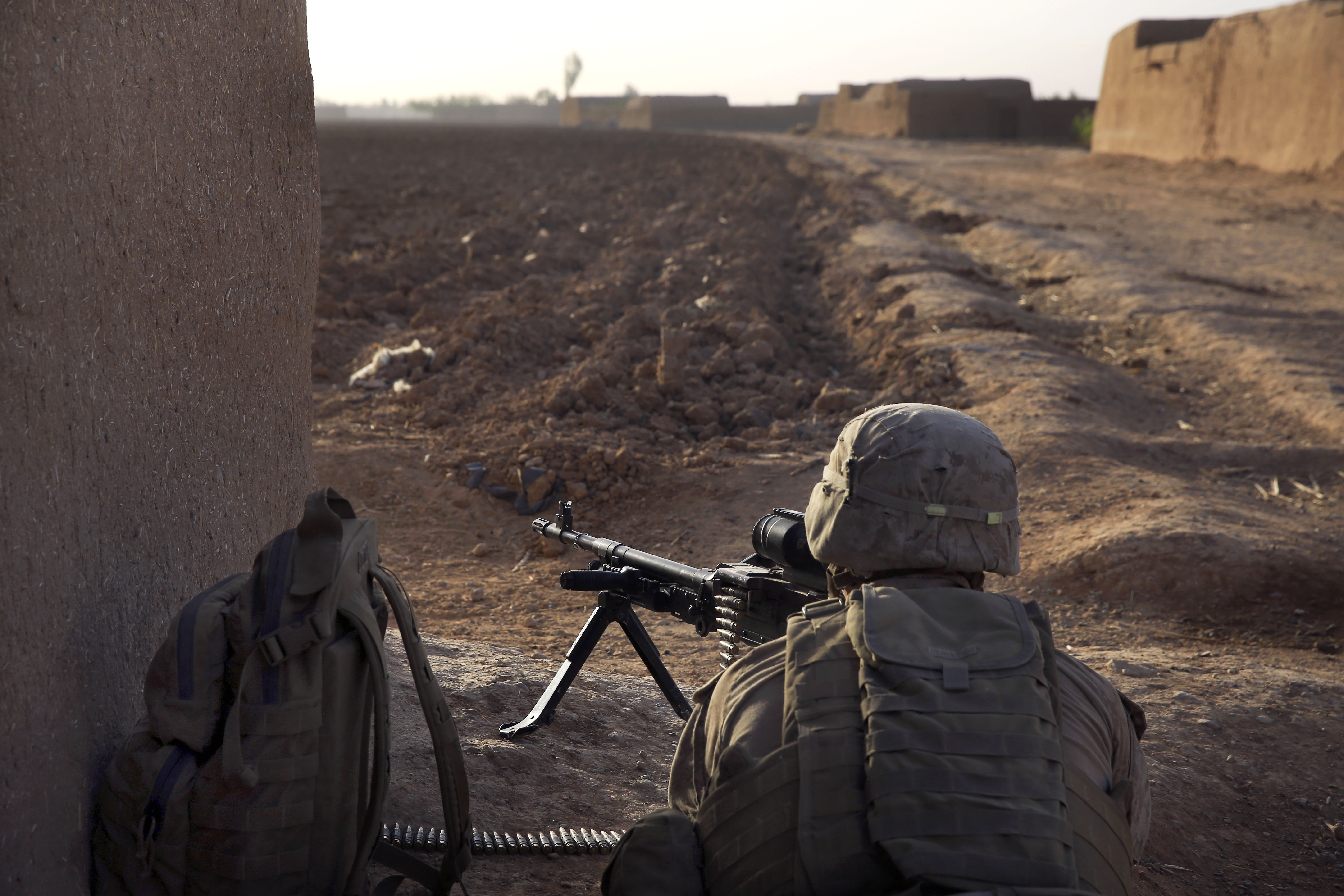 U.S. Marine Corps Cpl. Thomas Darden observes an area with his M240L ...