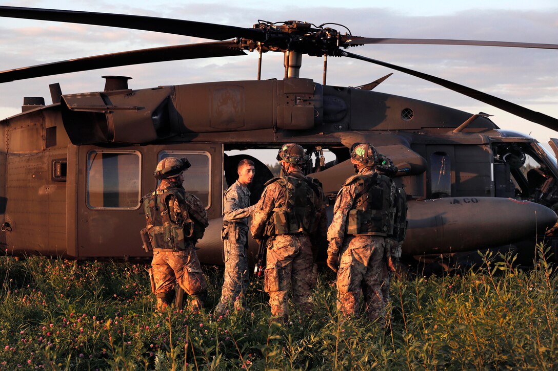 A U.S. soldier, second from left, briefs Italian paratroopers during ...