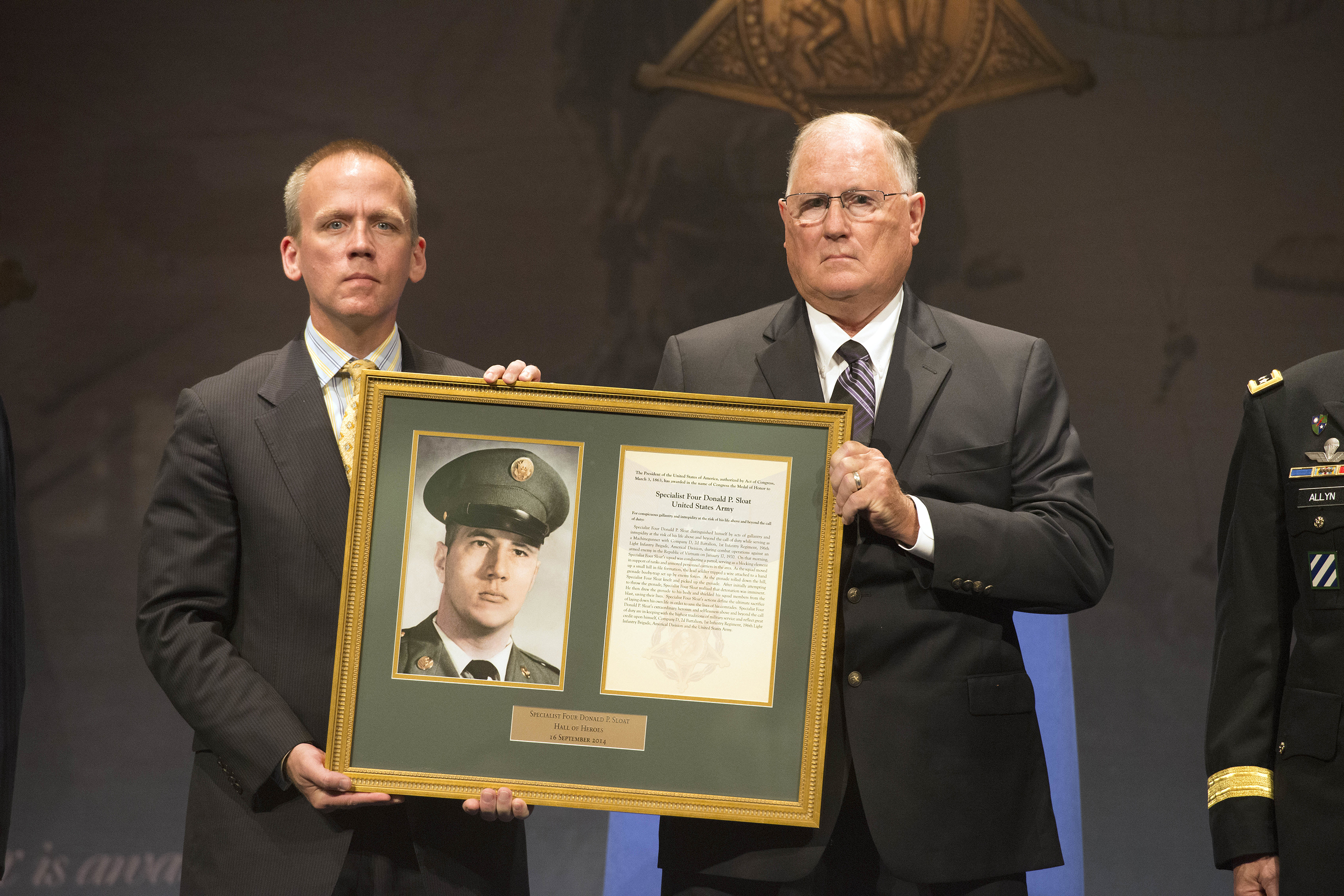 Undersecretary of the Army Brad R. Carson, left, and William Sloat ...