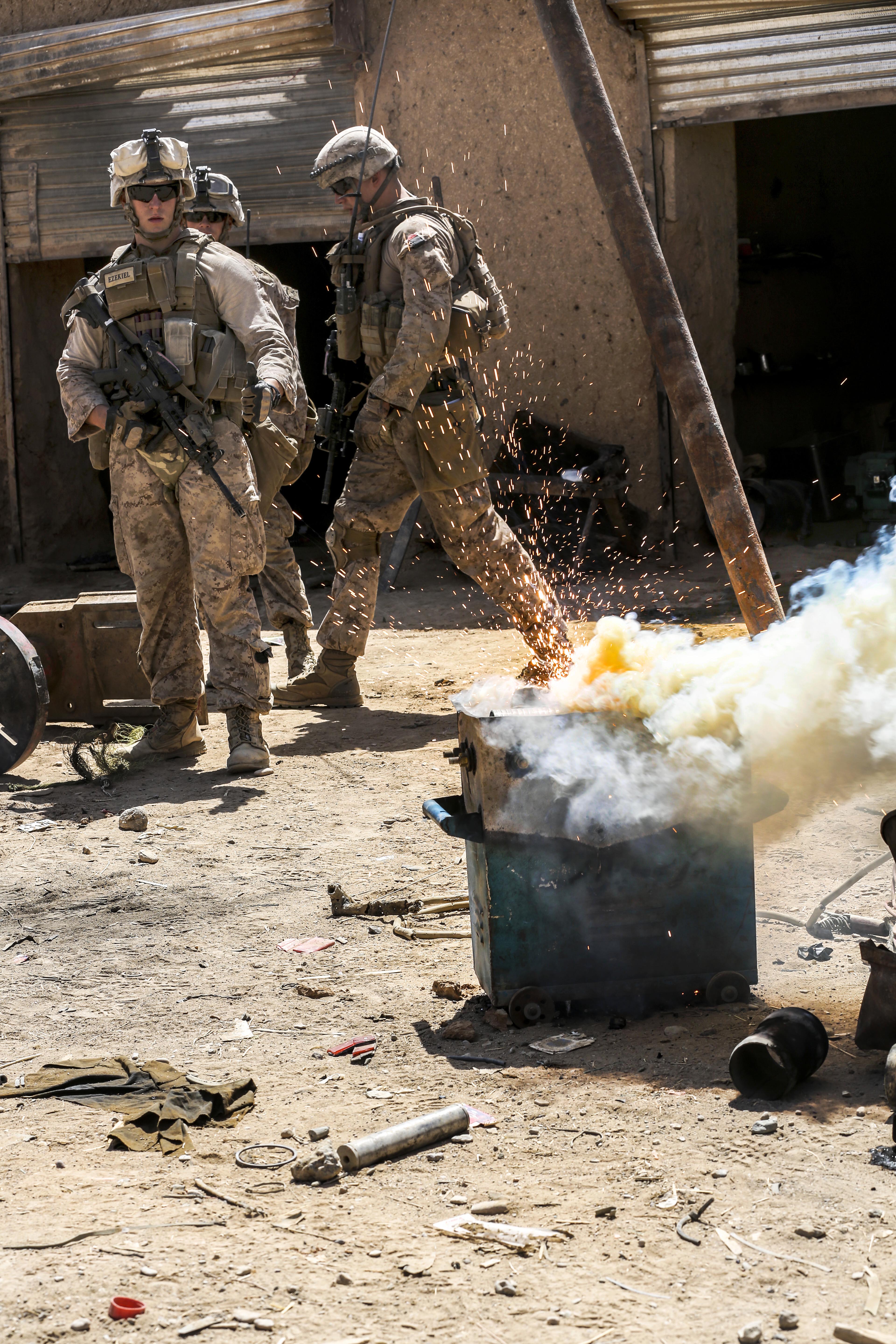 U.S. Marines utilize a thermite grenade to burn materials used for ...