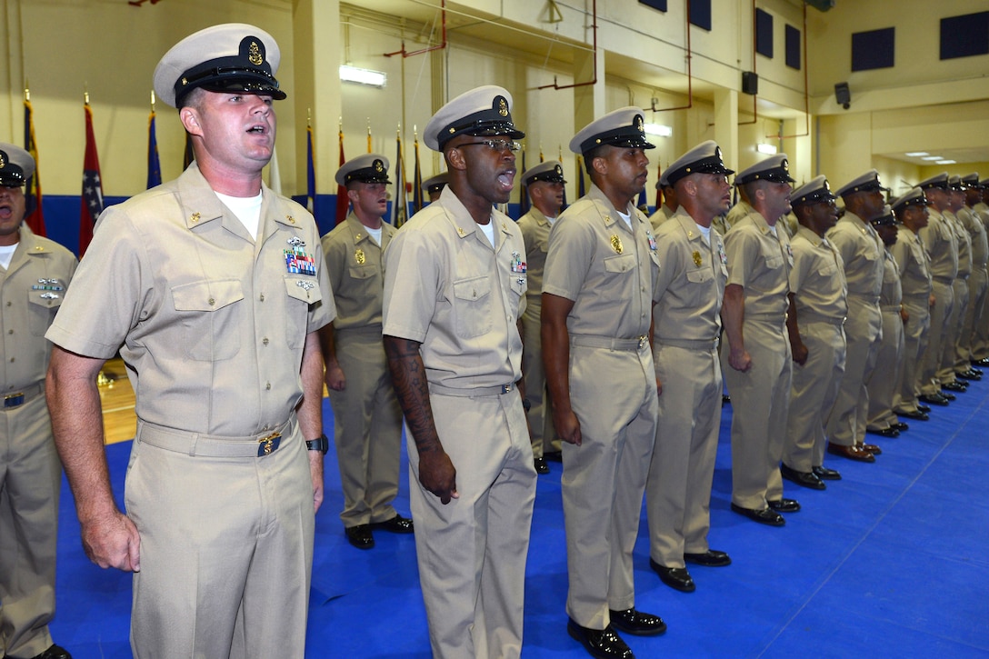 Newly promoted U.S. Navy chief petty officers sing "Anchors Aweigh ...