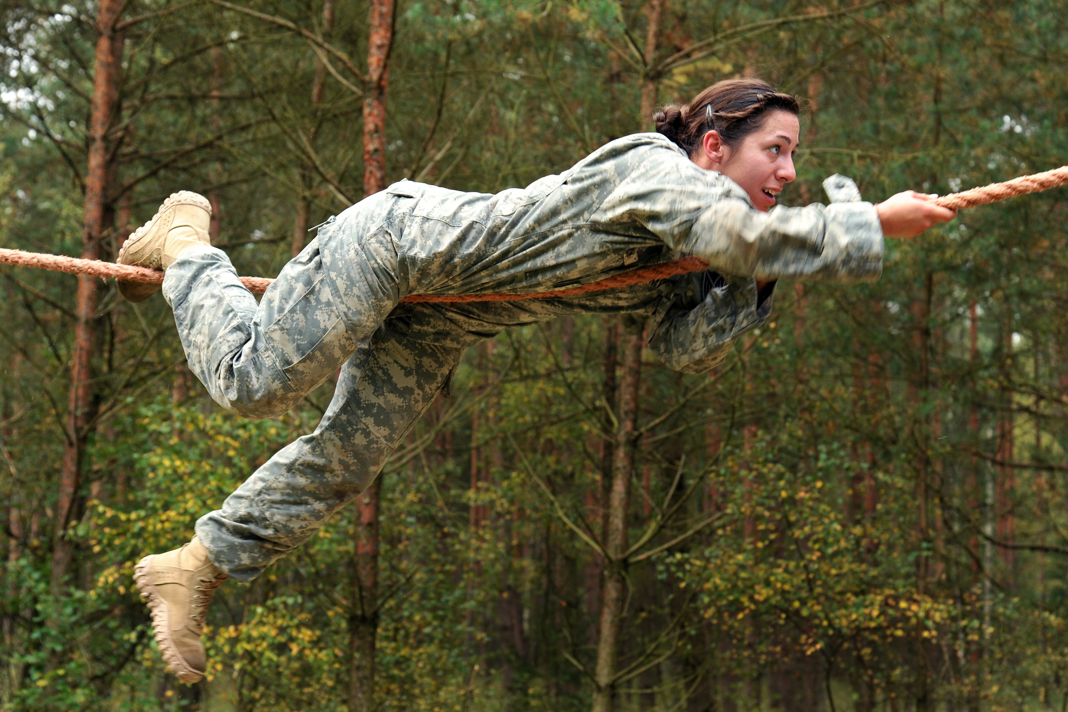 U.S. Army 2nd Lt. Kristen Daisy negotiates a rope obstacle during the ...
