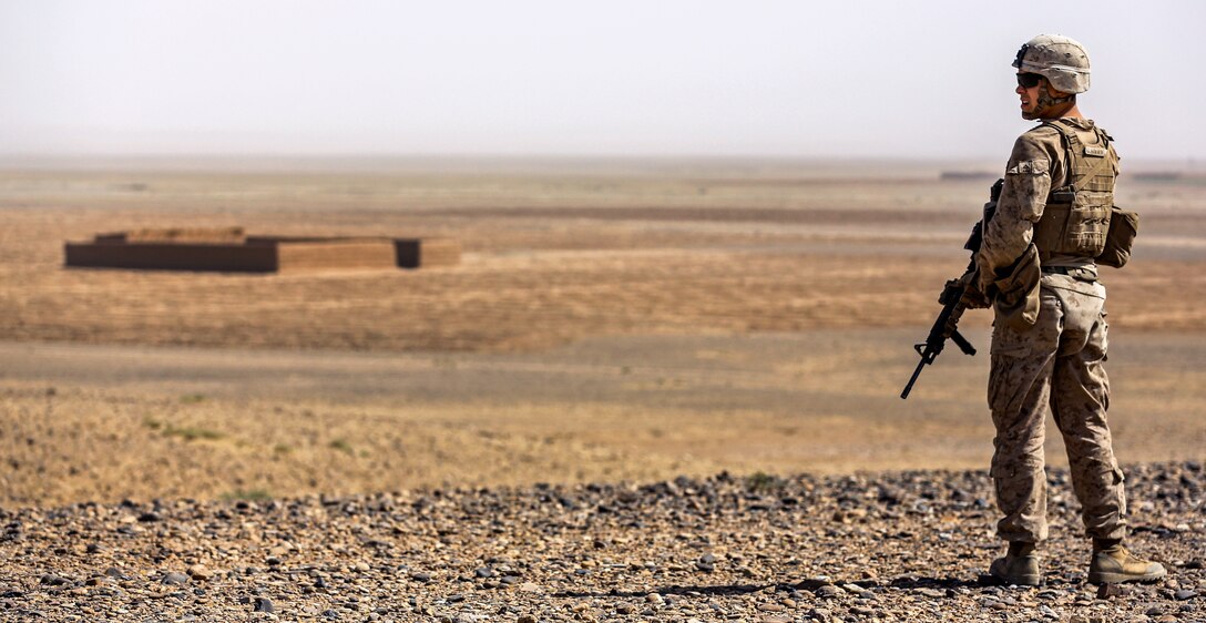 U.S. Marine Corps Lance Cpl. Corey Hammons observes his surroundings ...