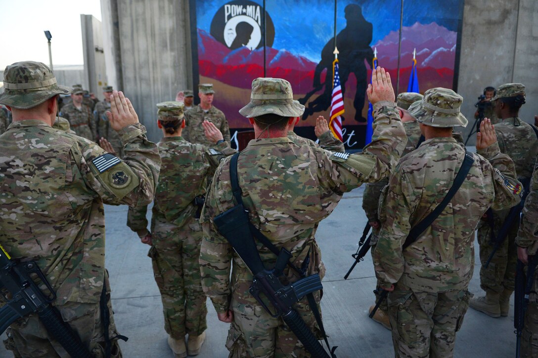 U.S. Air Force Brig. Gen. Mark D. Kelly re-enlistment airmen near Camp ...
