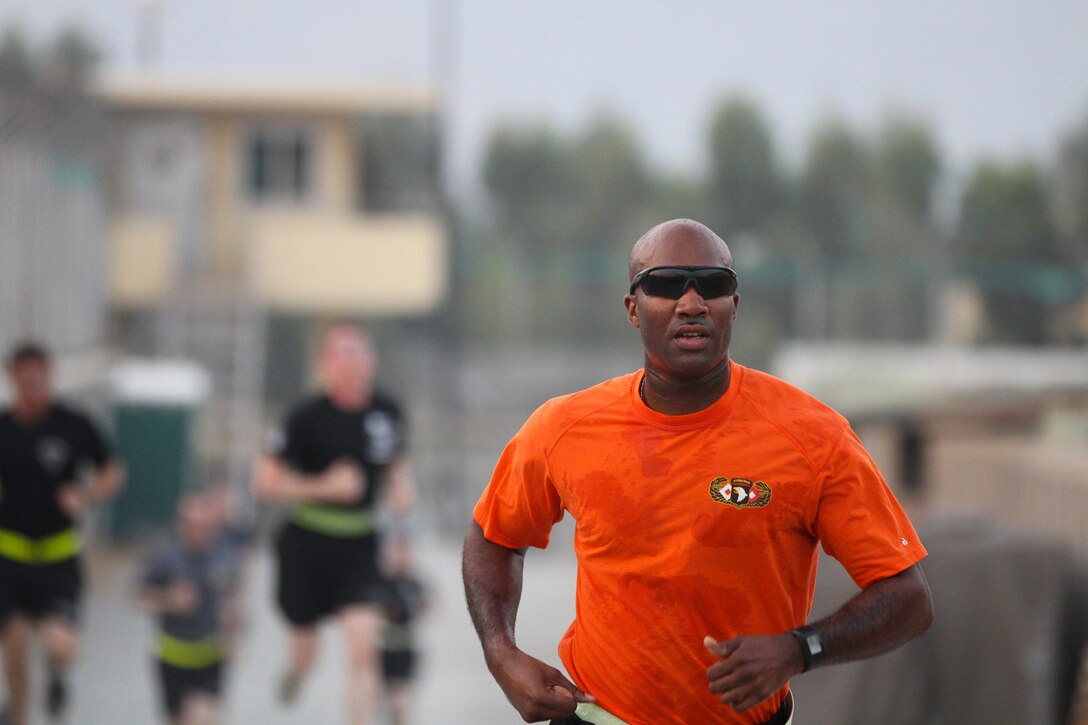 U.S. Army 1st Sgt. Maurice Davis runs up a hill during the memorial run ...