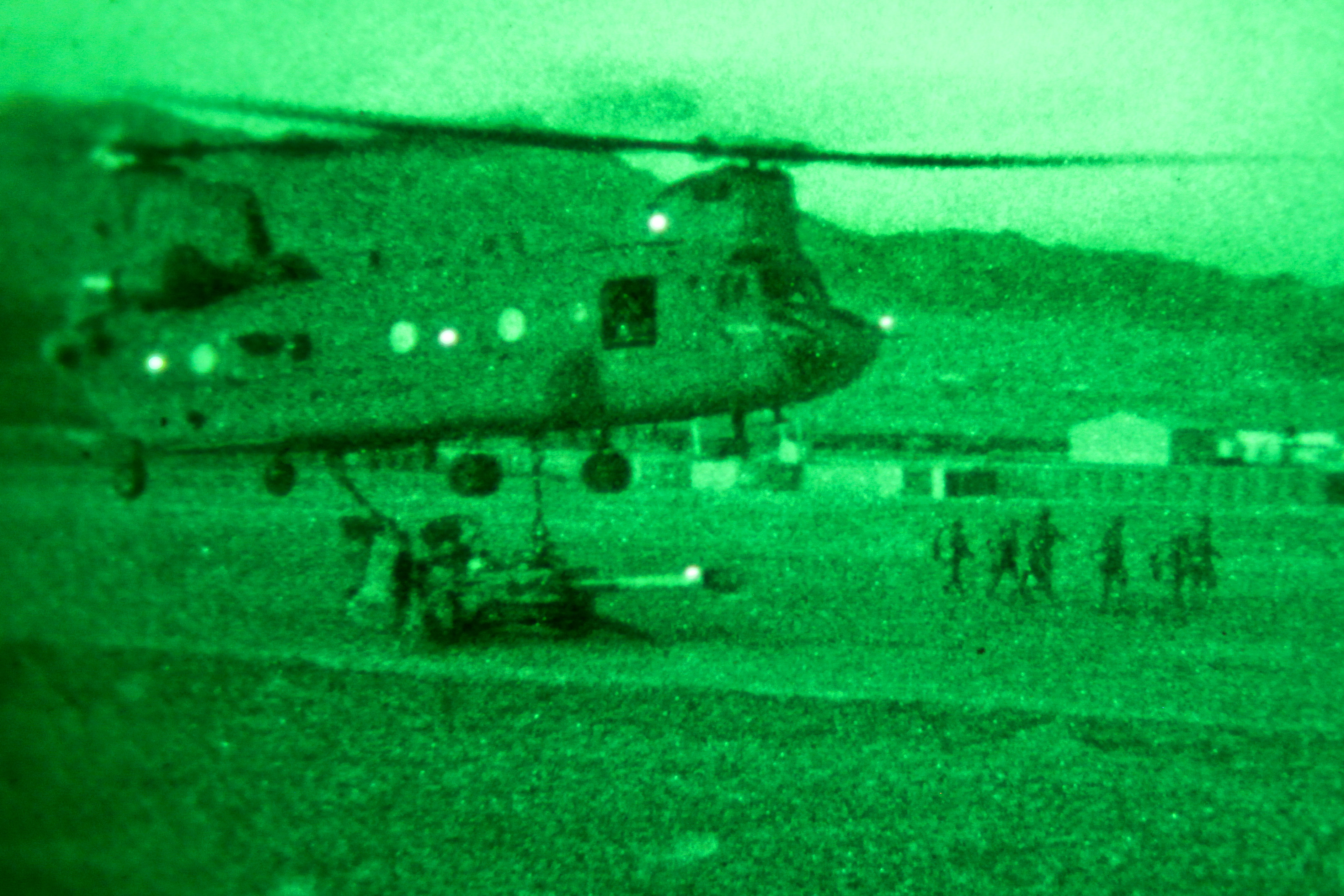 As seen through a night-vision device, U.S. soldiers move to a safe ...