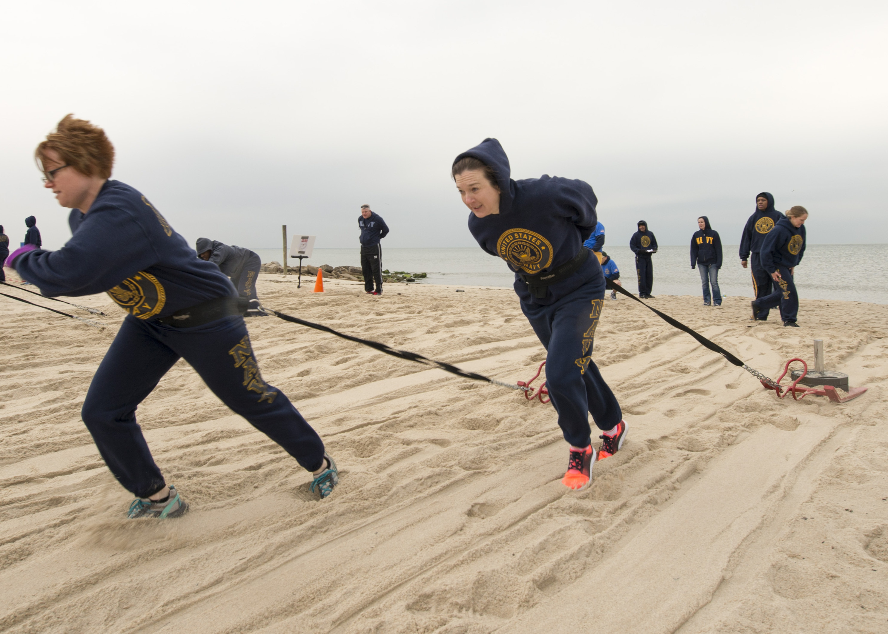 Navy Chief Petty Officers participate in a weighted sled pulling relay ...