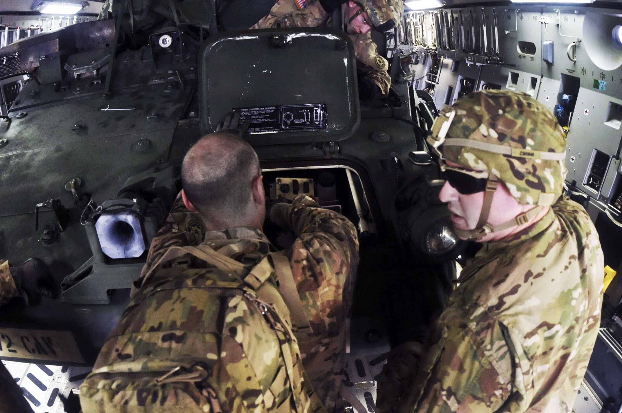 U.S. Army Staff Sgt. Derrick Guyton, left, Army Pfc. John Bivins, top ...