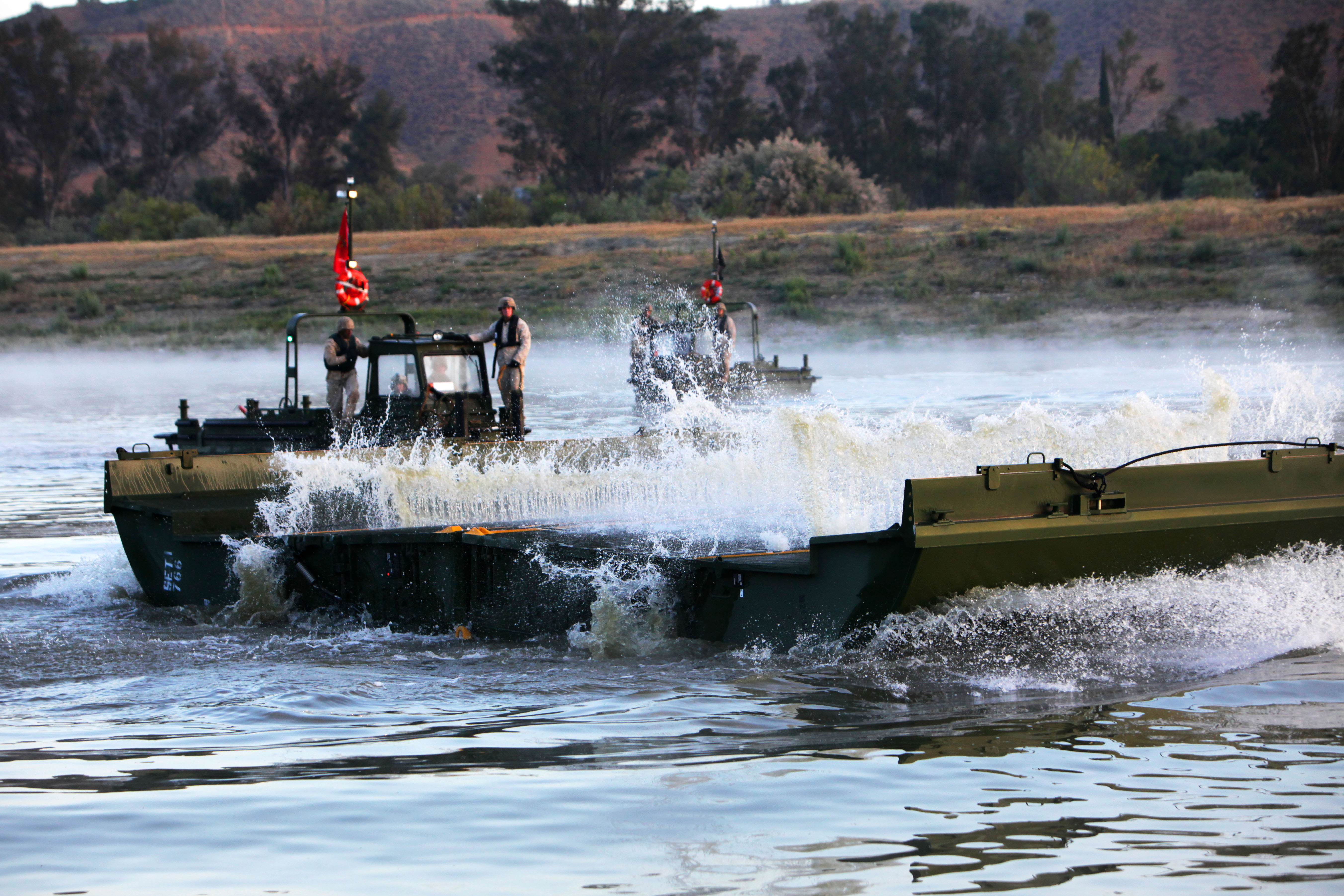 Marines release a portion of an Improved Ribbon Bridge during a bridge ...