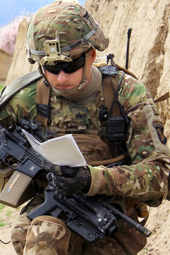 U.S. Army Sgt. Oliver reads a map during a break while patrolling ...