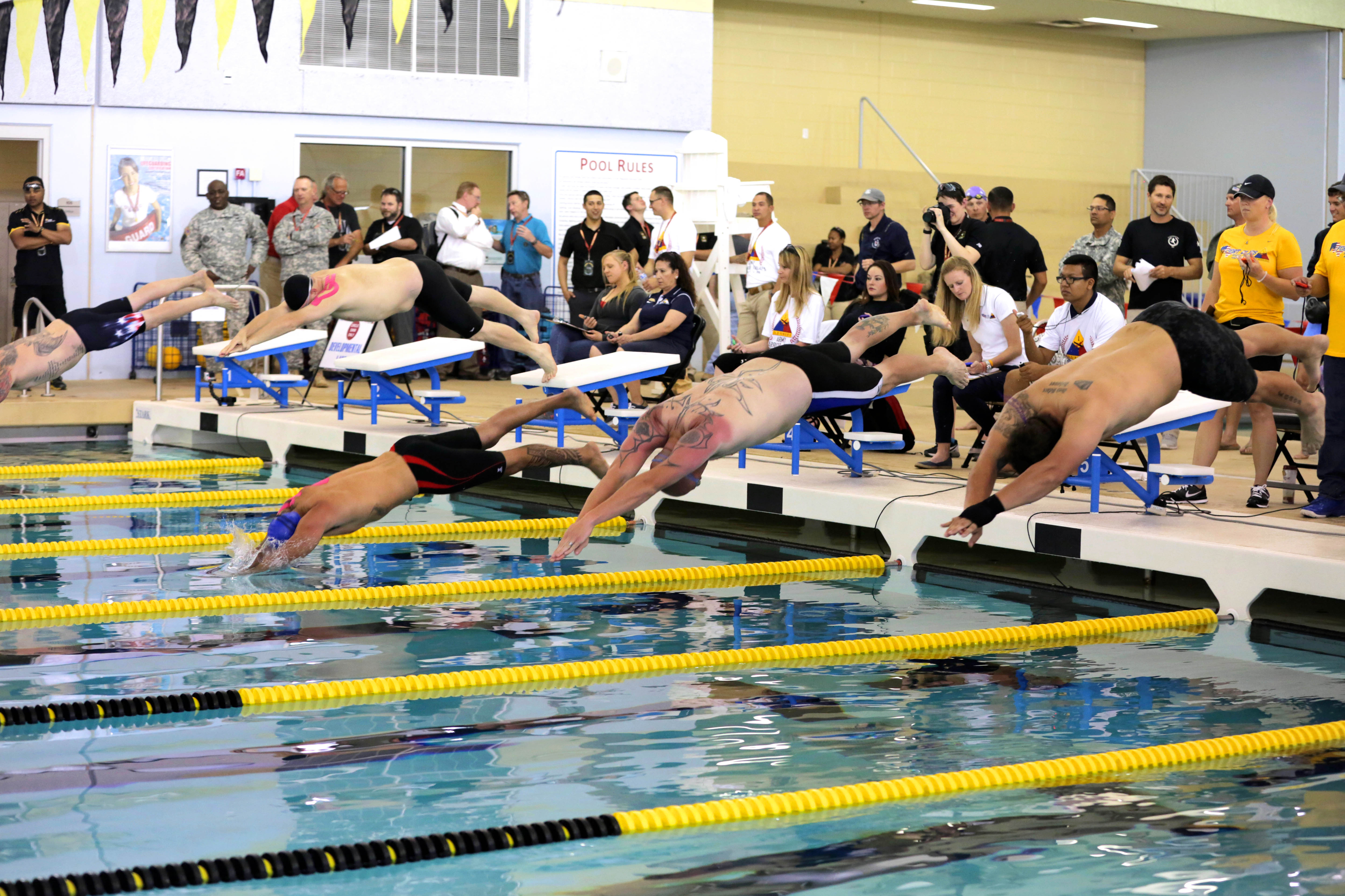 Soldiers and veteran athletes dive into the water during the 2015 Army ...