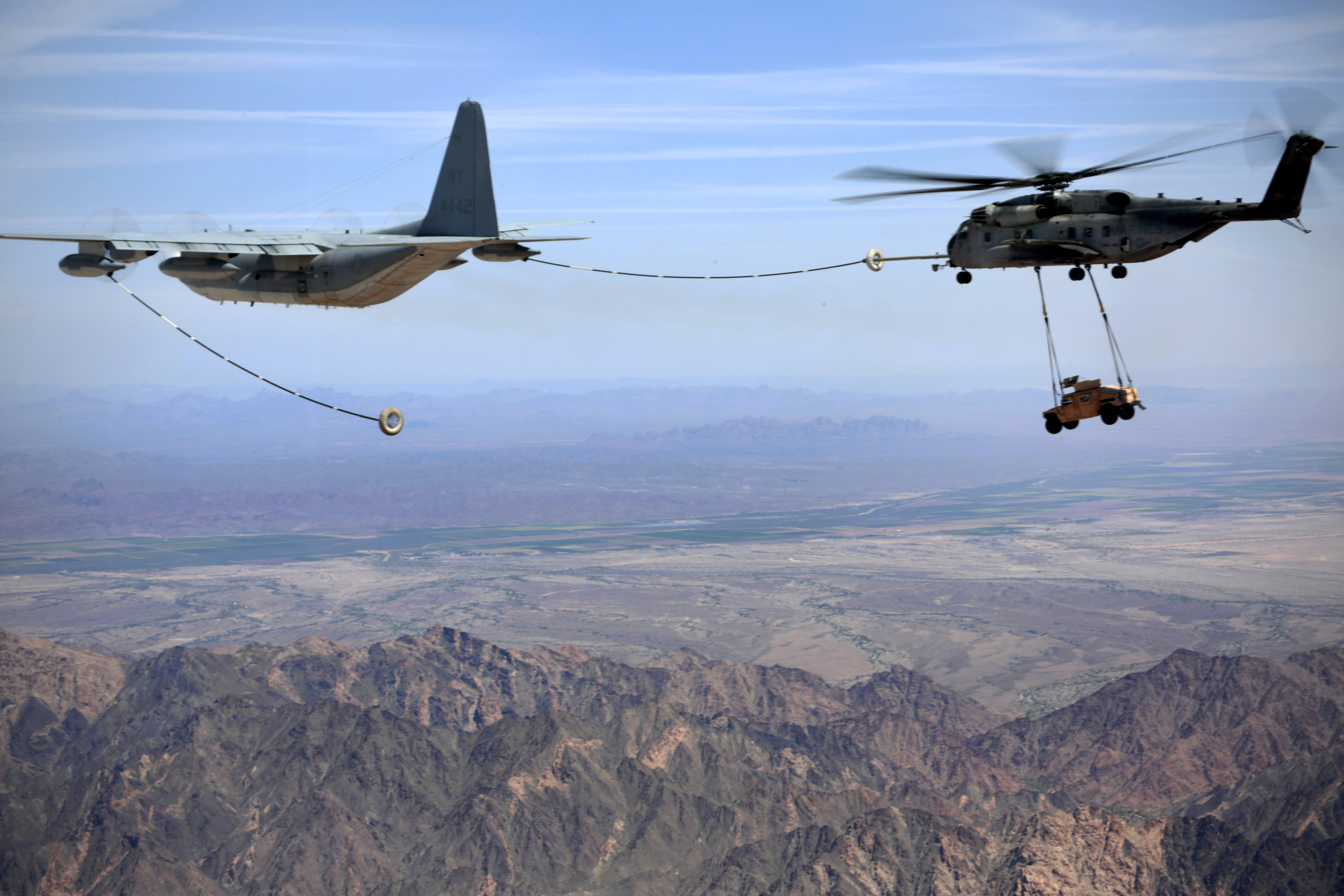 A Marine CH-53E Super Stallion helicopter conducts aerial refueling ...