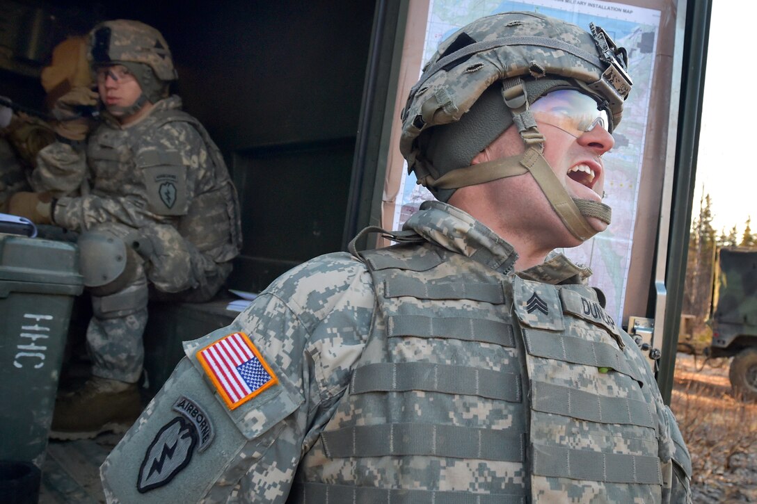 Army Sgt. Dustin Dunlap yells a fire-mission order to his soldiers to ...