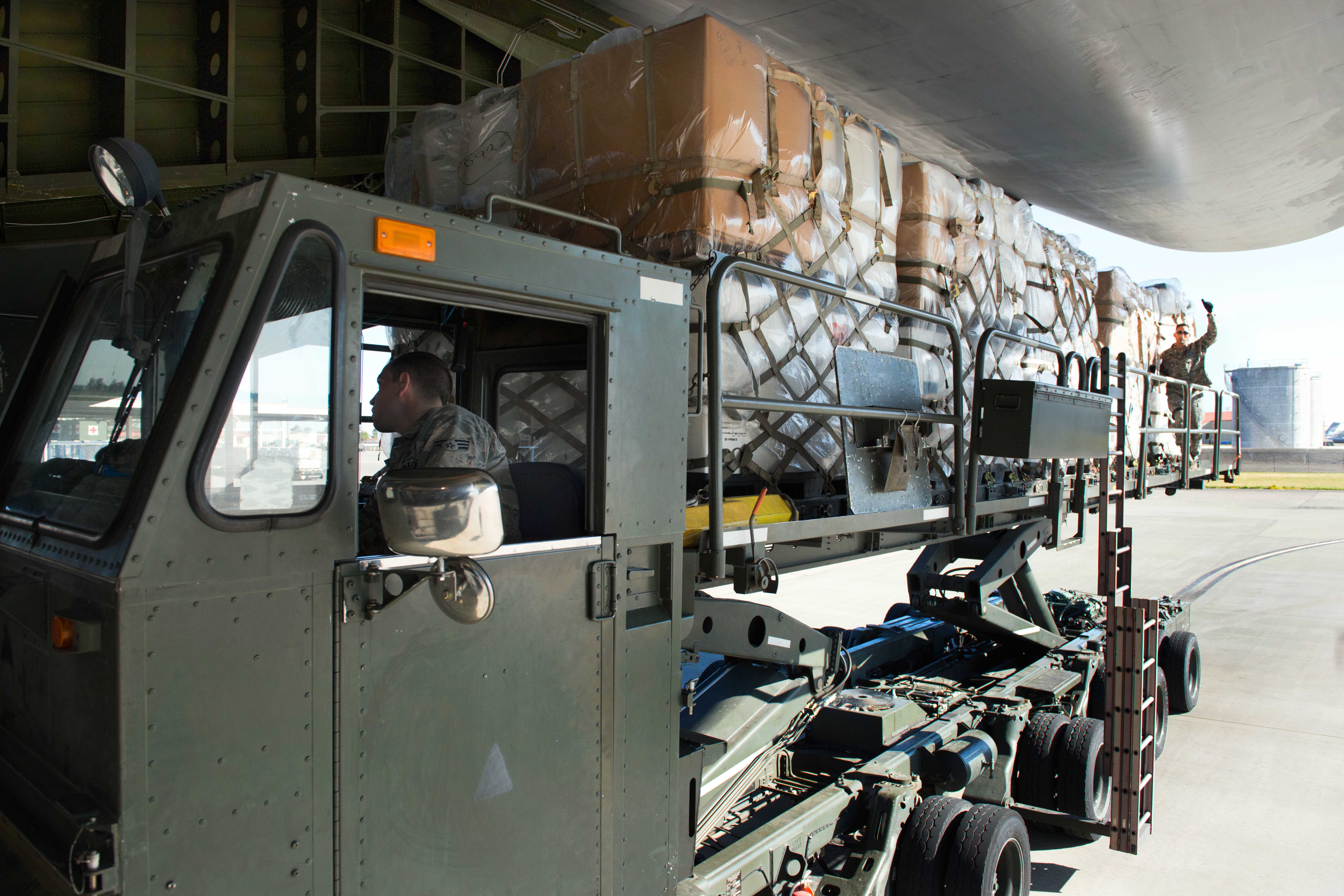 Airmen prepare to transfer pallets from a loader onto a C-5M Super ...