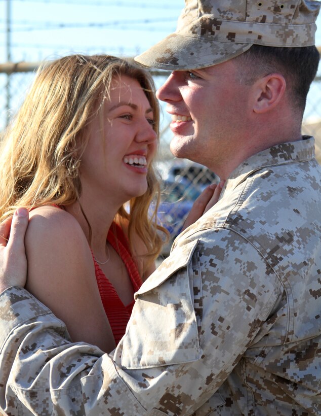 Marine Corps Lance Cpl. Trey Spencer embraces his girlfriend, Haliegh ...