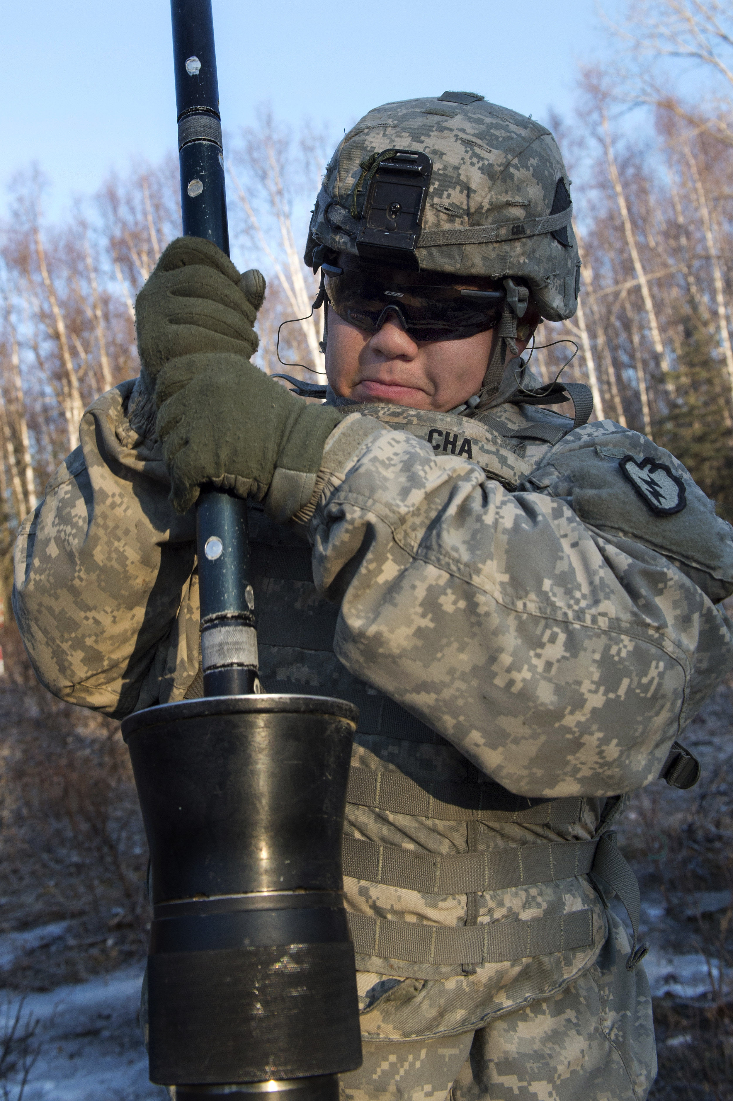 Army Spc. Kevin Cha cleans an M252 81-mm mortar system tube during live ...