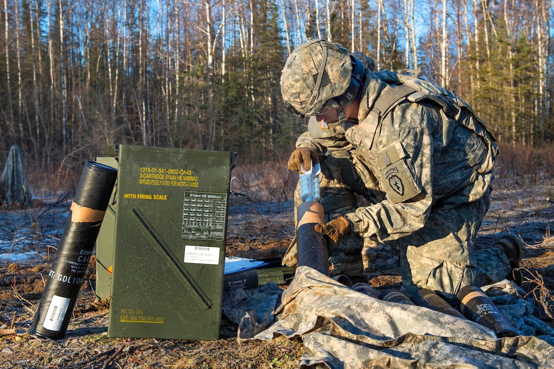 Army Pvt. Riley Eggeman unpacks M252 81-mm mortar ammunition during ...