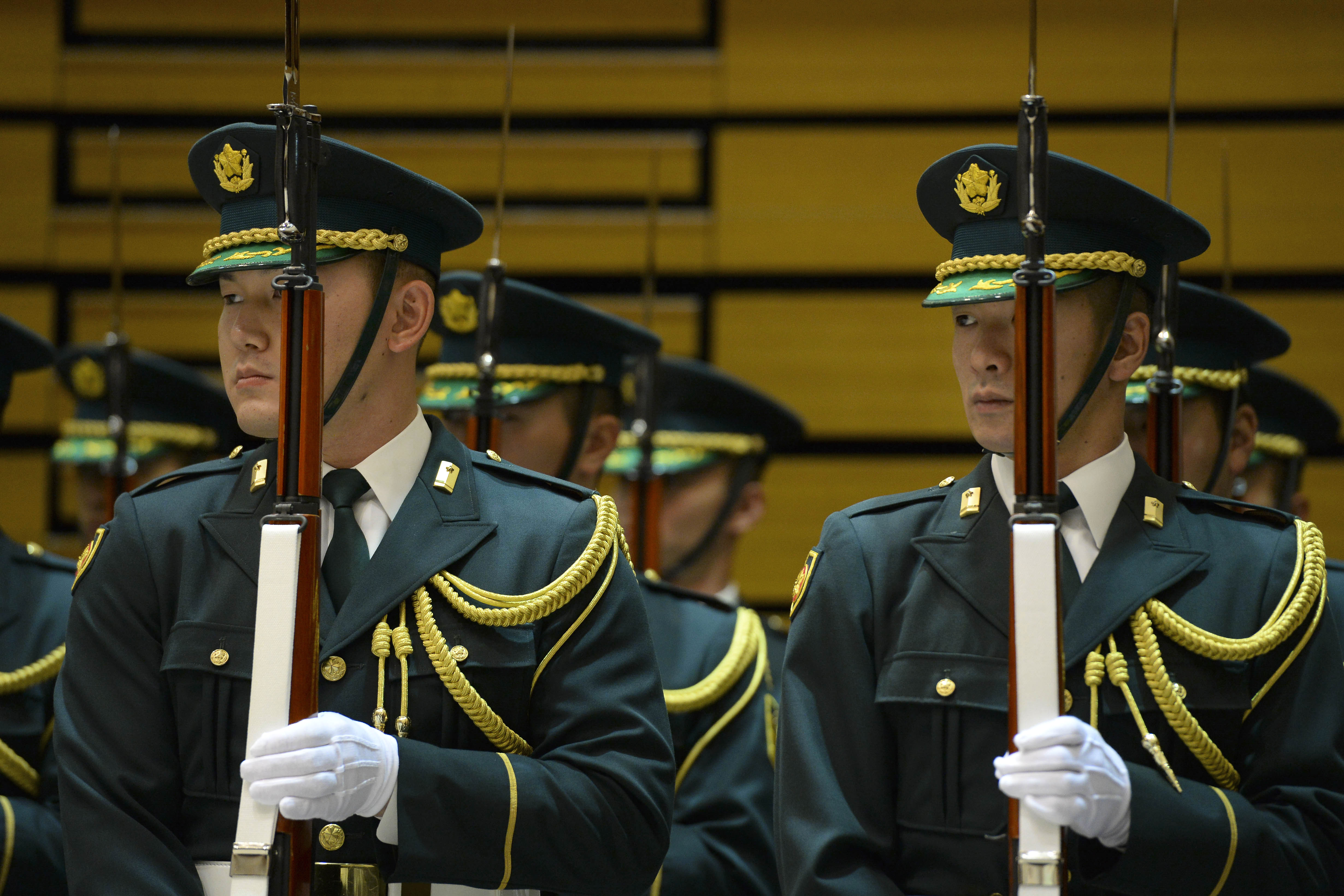 Members of the Japanese honor guard stand at attention during a ...