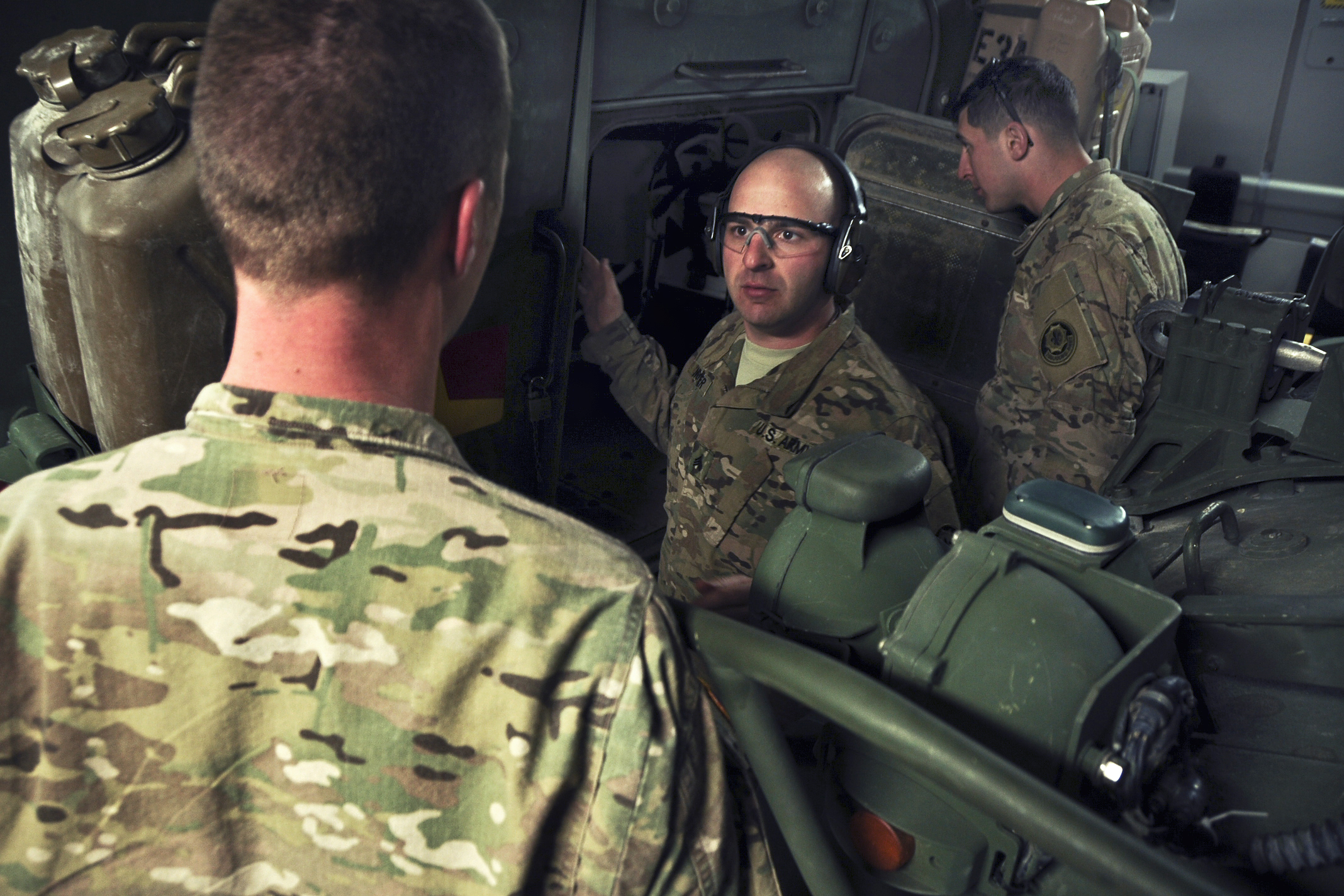 Army 1st Lt. Paul T. Merten, left, talks with Army Sgt. Brandon M ...