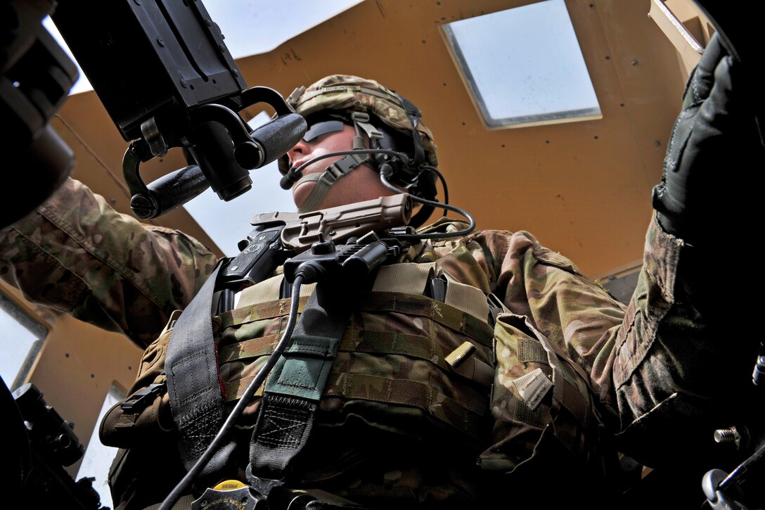 A U.S. soldier mans his machine gun from the turret of an mine ...
