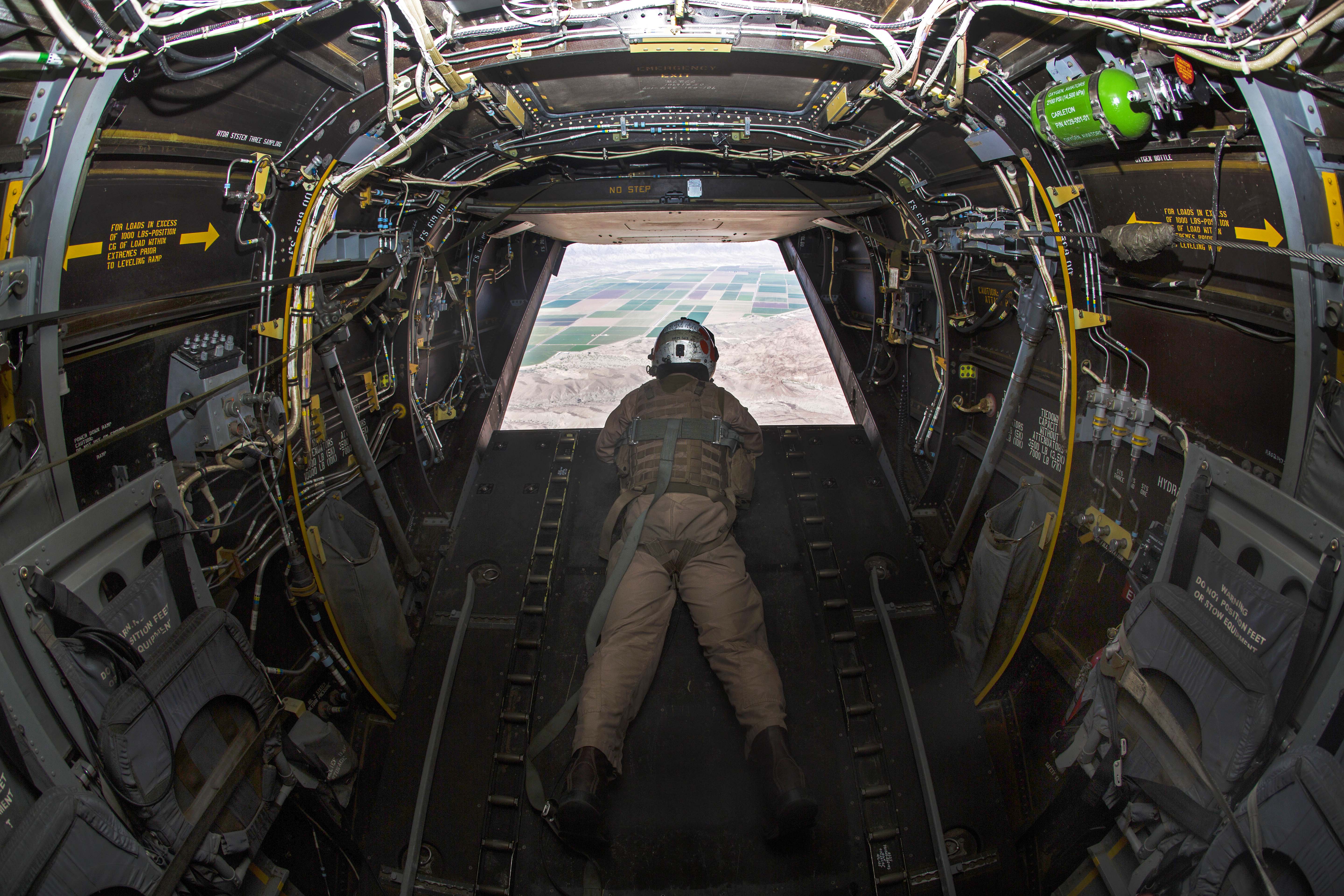 Marine Corps Cpl. Dilon A. Richter observes the flanks of an MV-22 ...