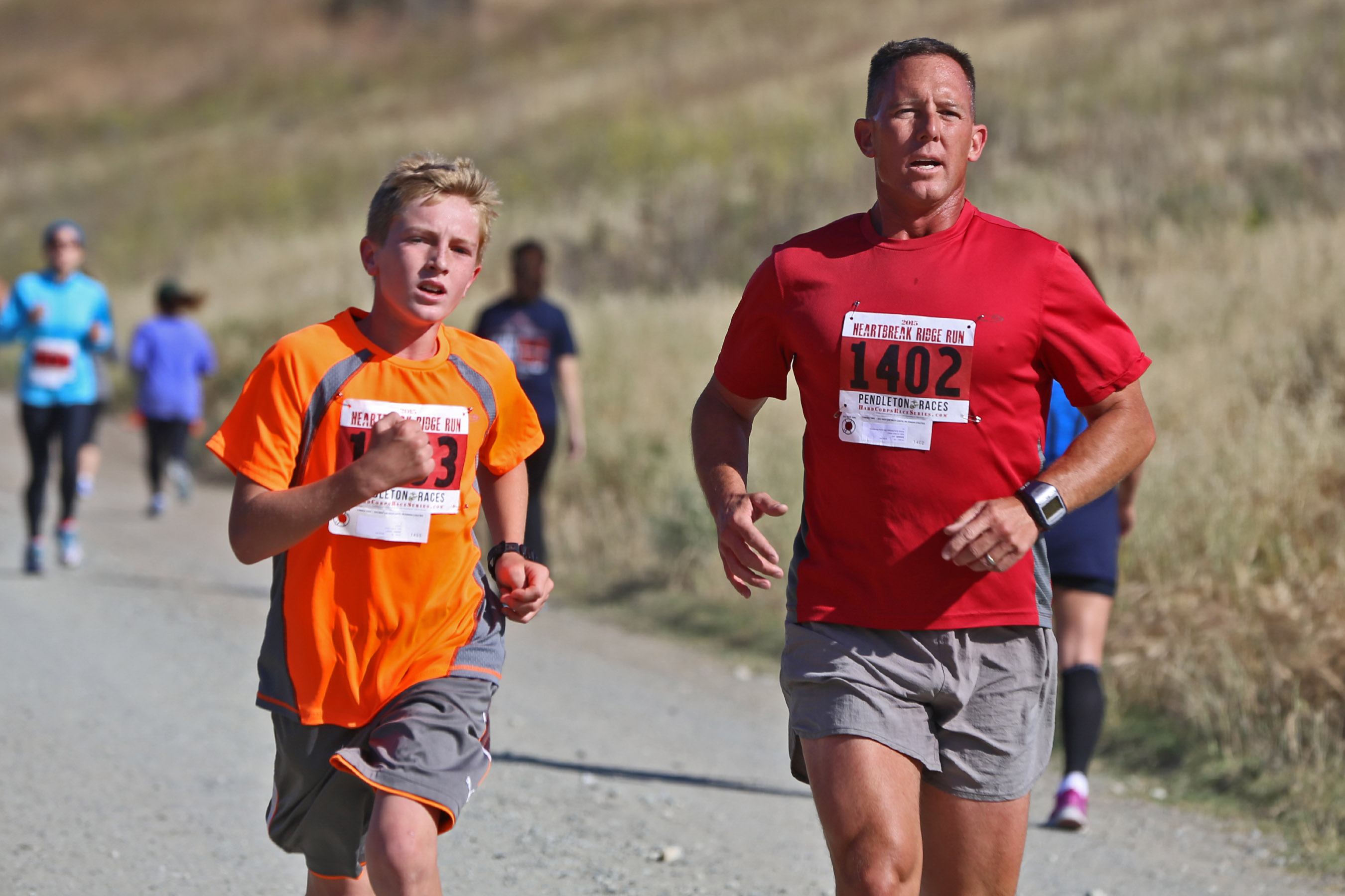 Runners race through rolling hills during 2015 Heartbreak Ridge Run