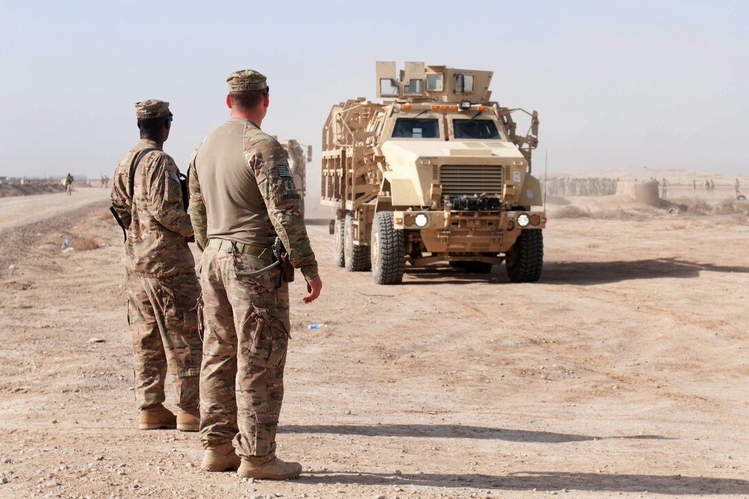 U.S. soldiers observe as Iraqi soldiers conduct a driver’s training ...