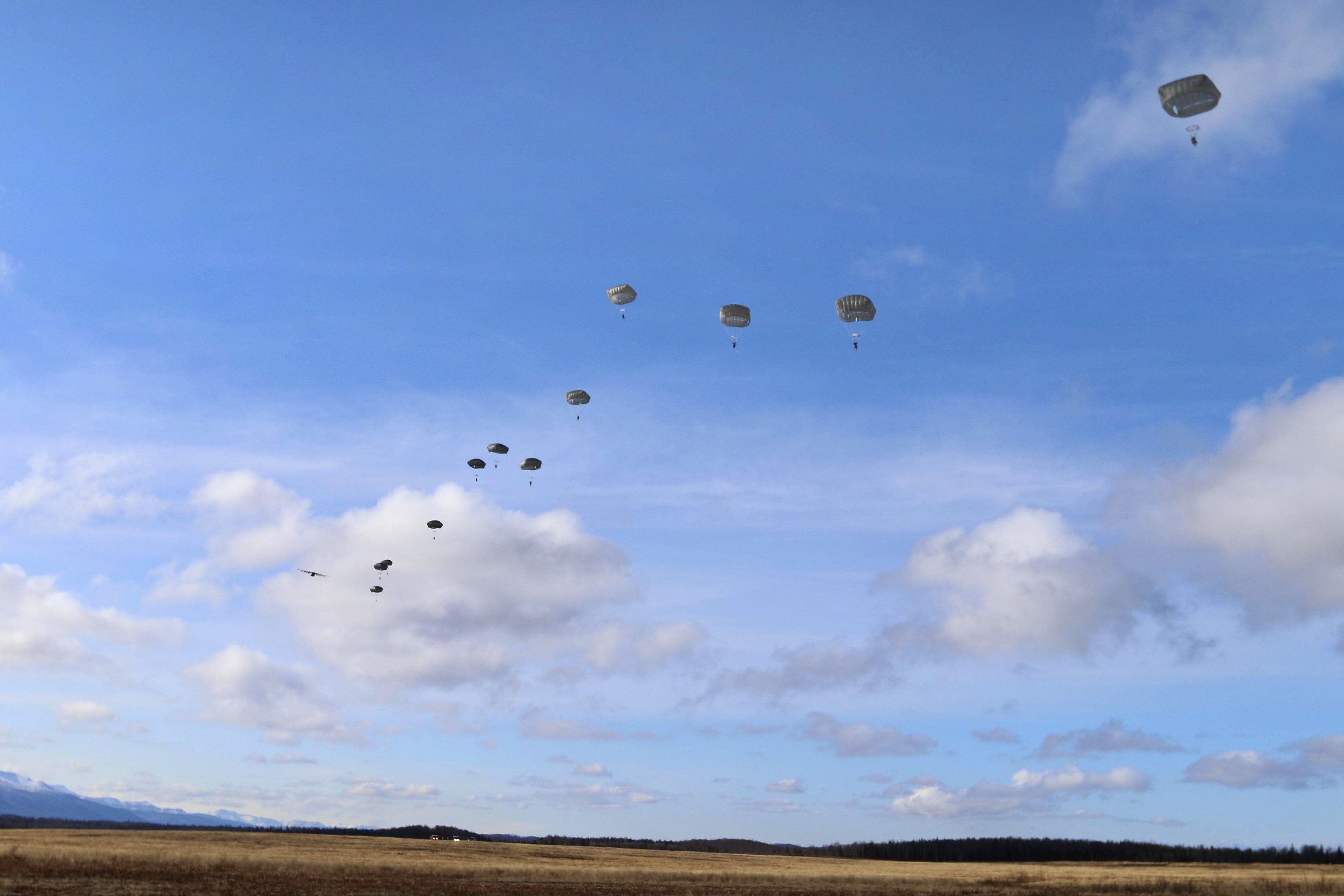Paratroopers parachute down over Malemute drop zone on Joint Base ...