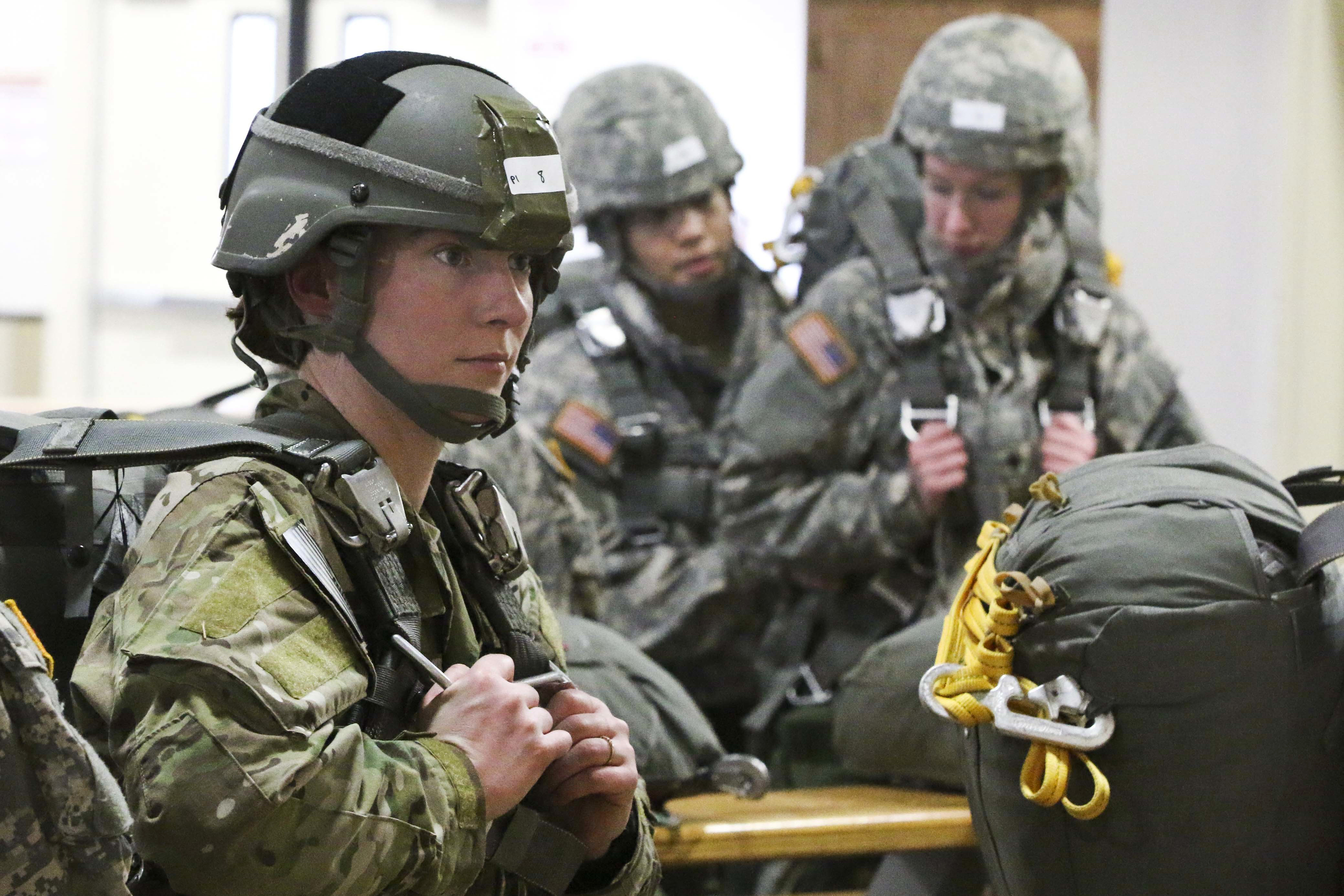 Paratroopers buddy rig their T-11 parachutes at the Joint Mobility ...