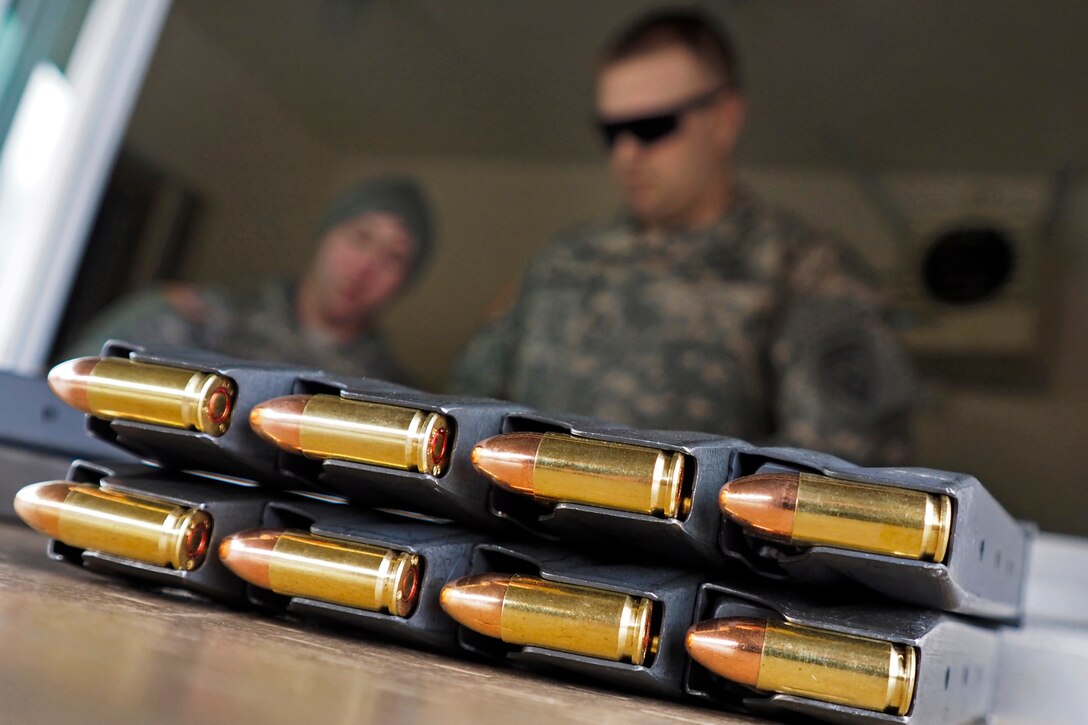 Paratroopers count ammunition while soldiers qualify with M9 pistols on ...