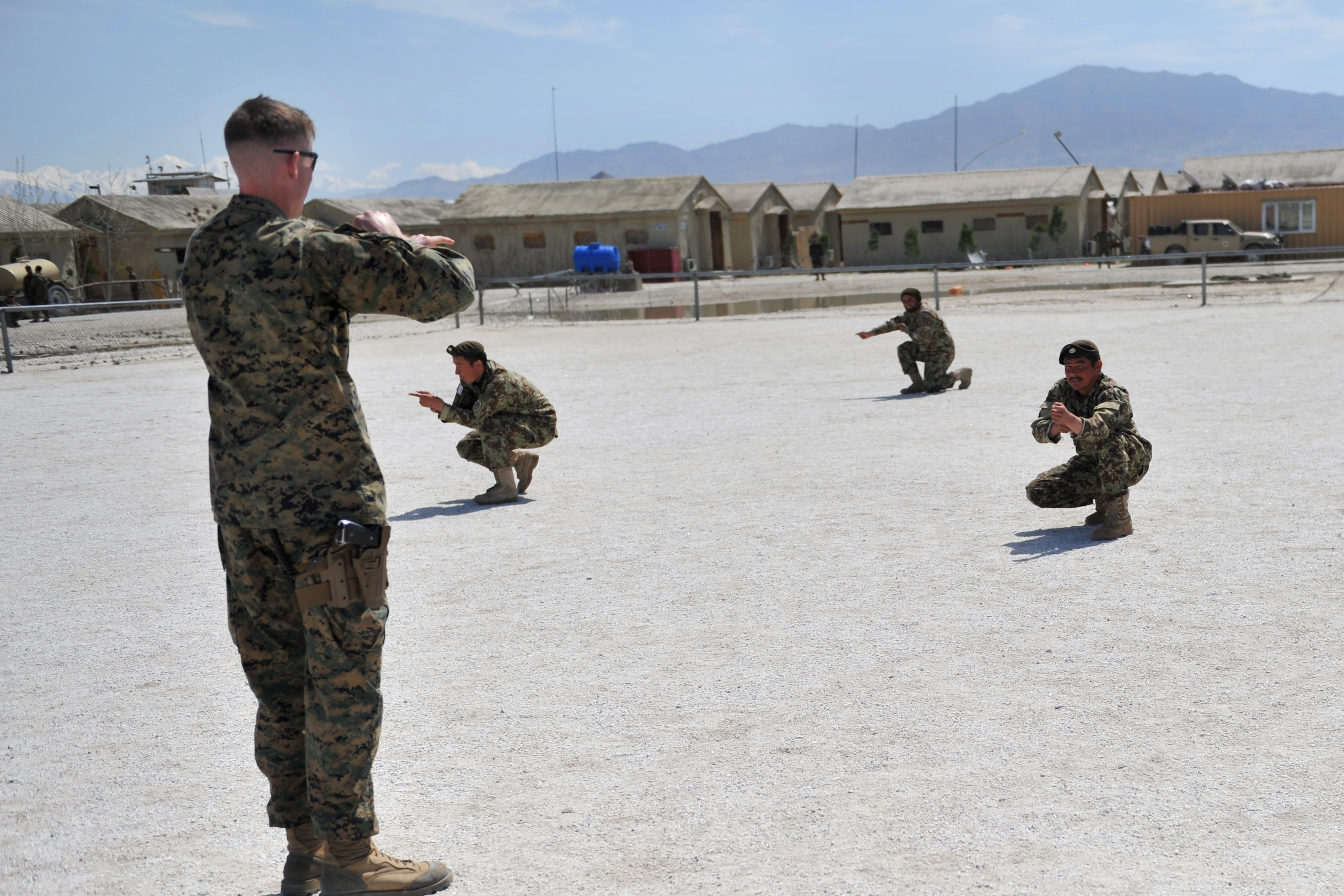 A U.S. Marine demonstrates infantry tactics and techniques to Afghan ...