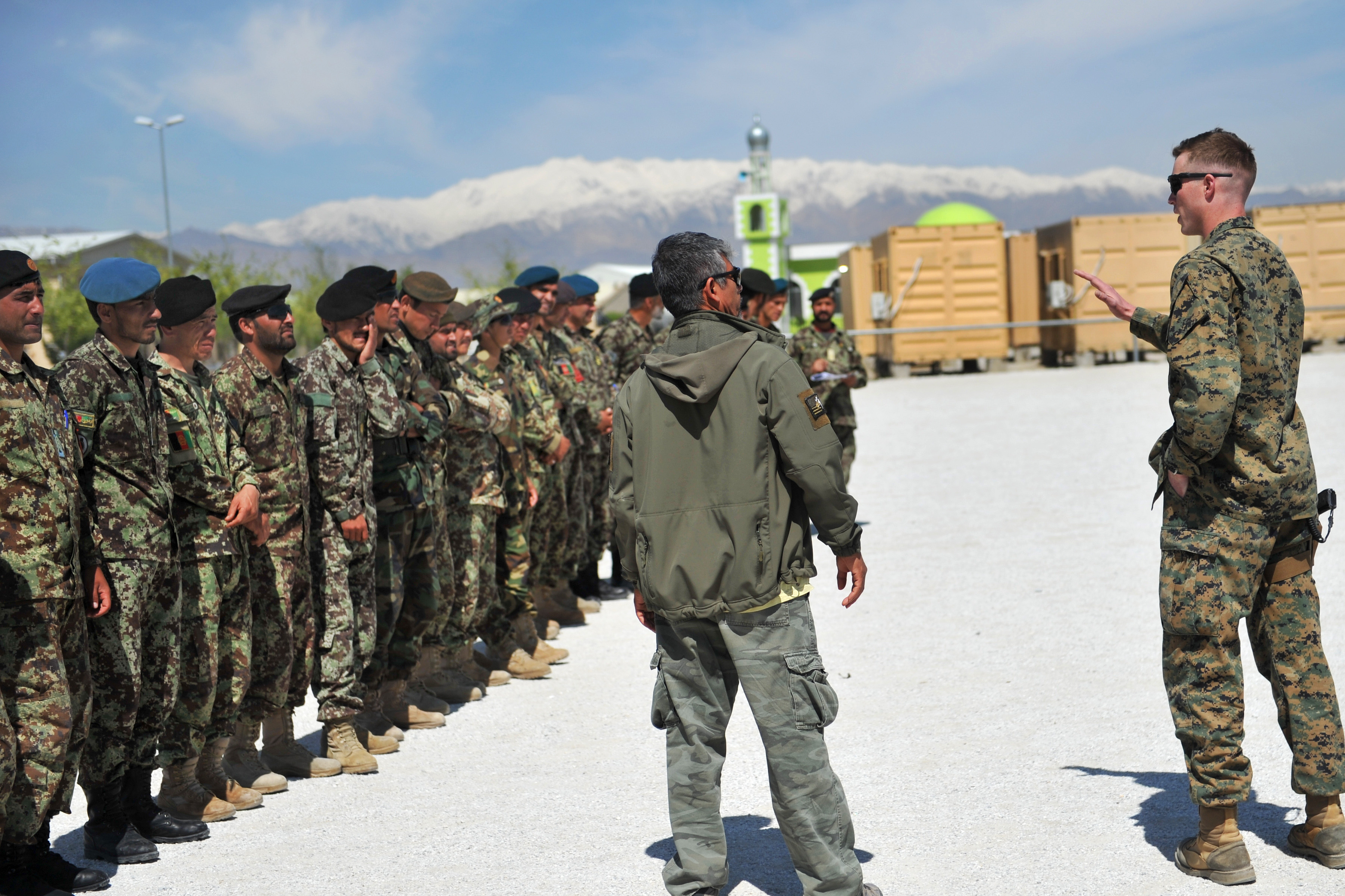 U.S. Marine Corps 1st Lt. Andrew Dixon, right, talks to Afghan military ...