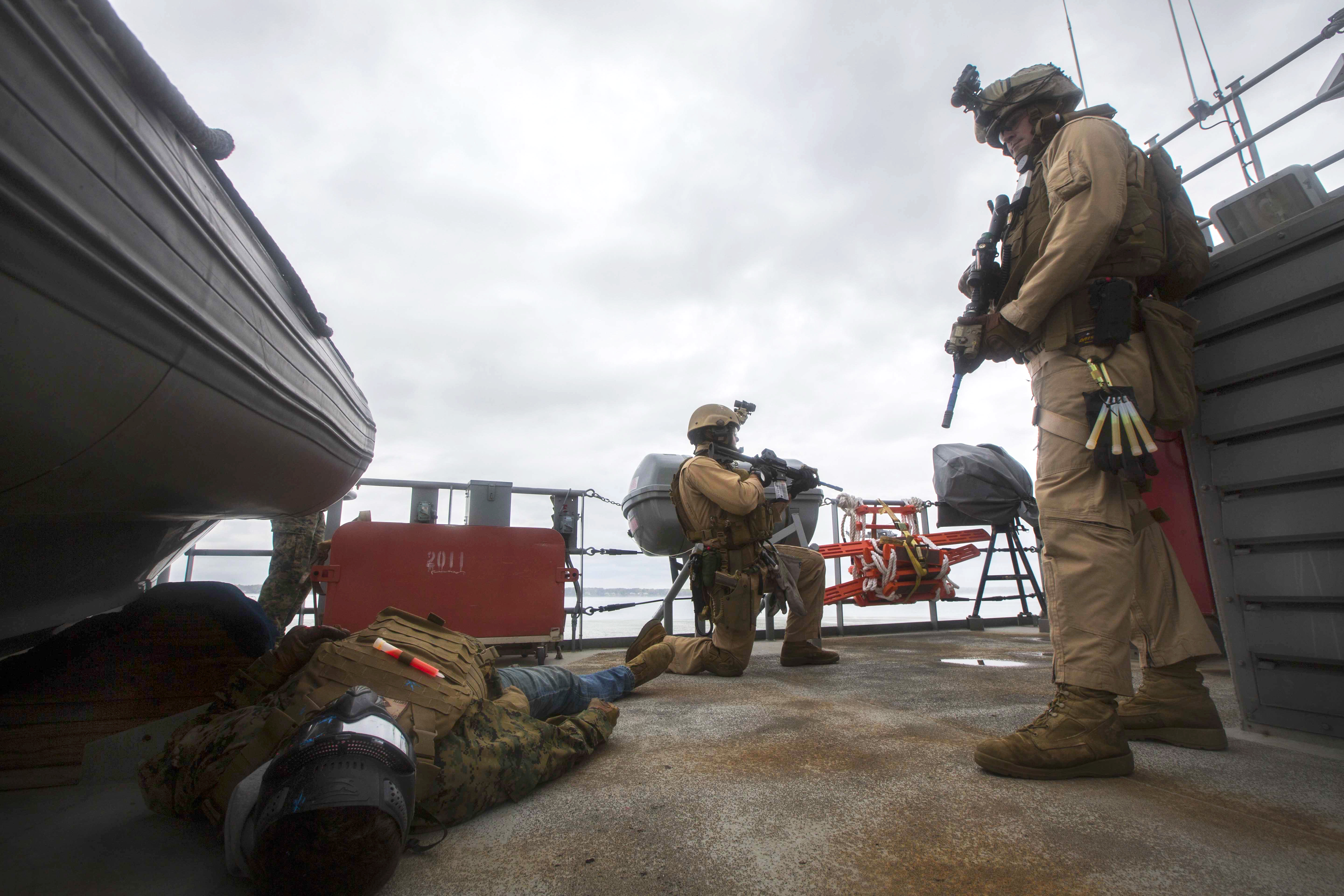 Marines secure an area after engaging a simulated enemy combatant ...