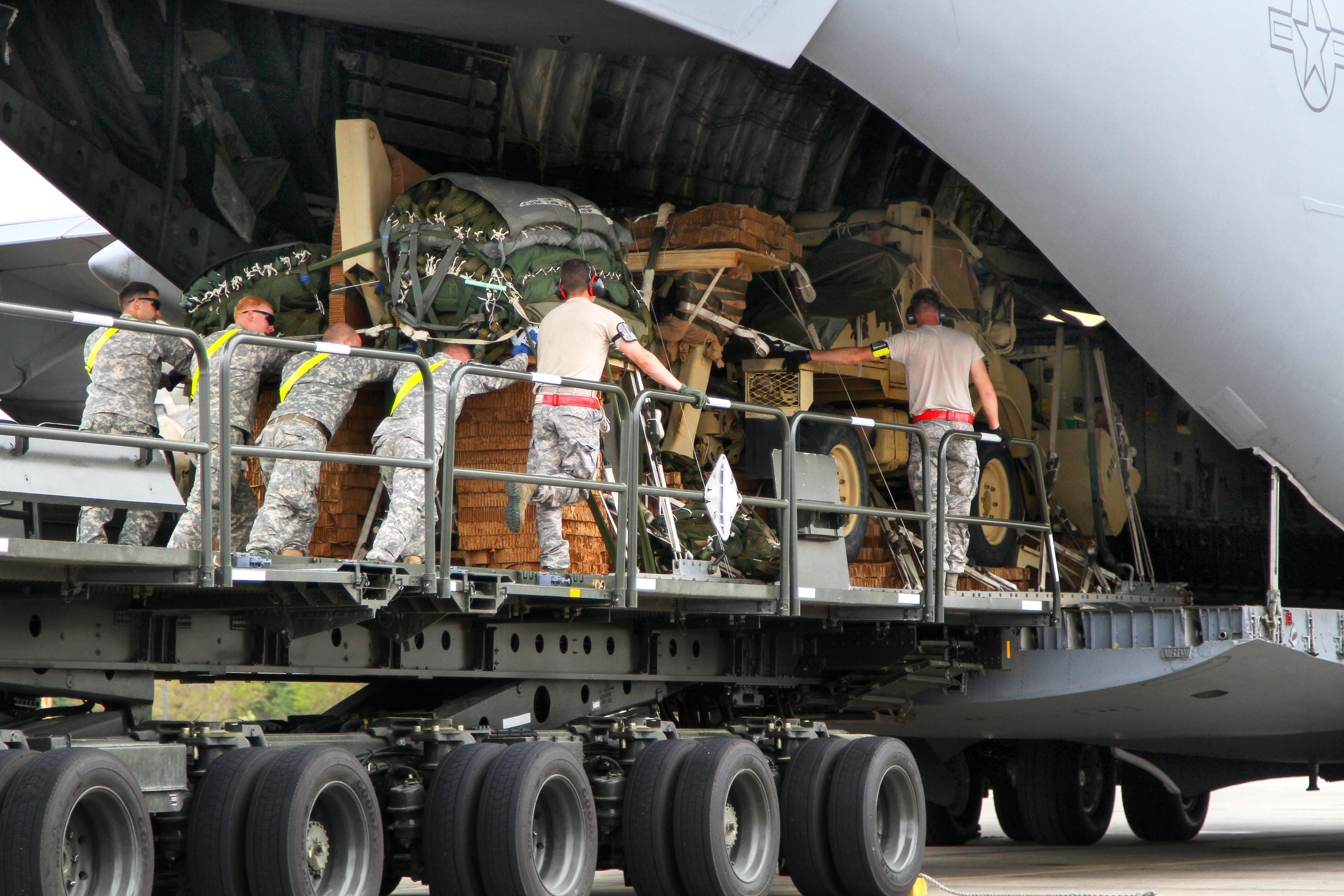 Army paratroopers and Air Force airmen load vehicles and equipment onto ...