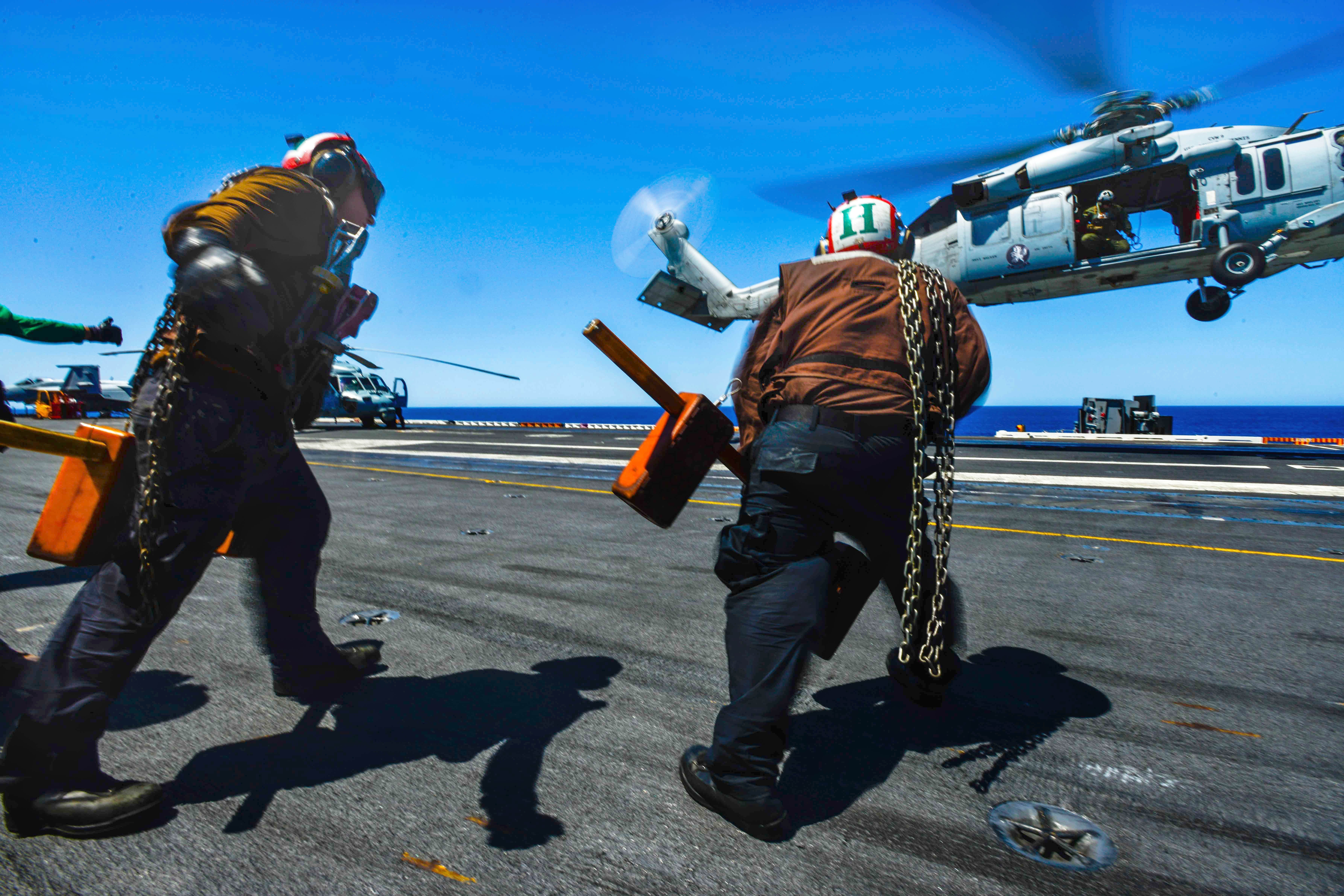 U.S. Navy Seaman Tyler Krumtum and U.S. Navy Petty Officer 2nd Class ...