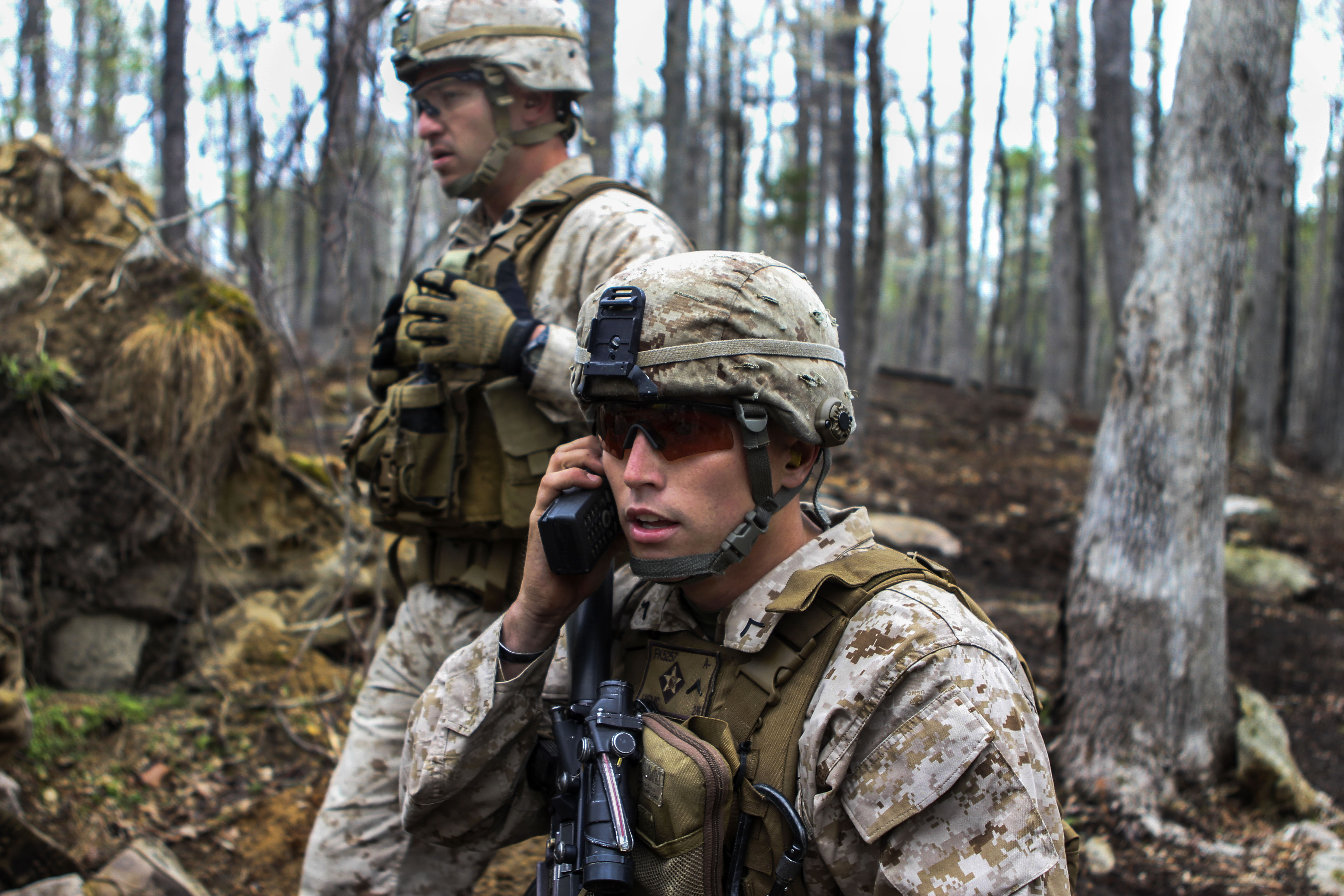 Marine Corps Pfc. Fletcher Klossing radios commands to the machine gun ...