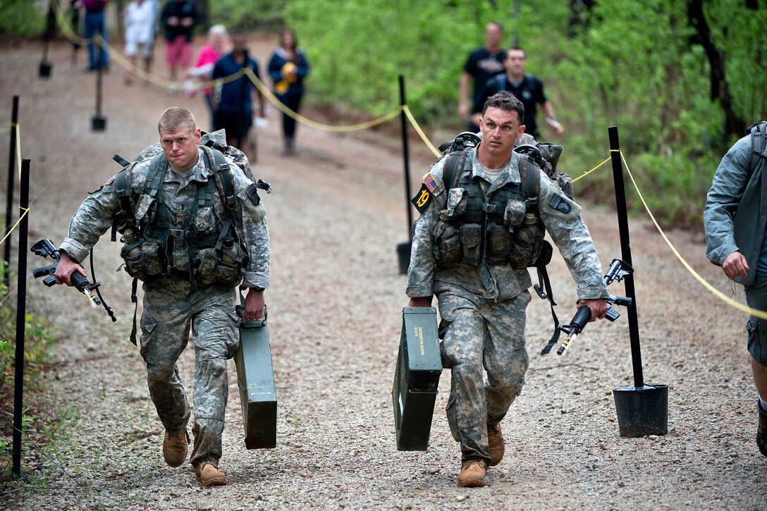 Army 1st Lt. Brian Rowan, left, and Army Staff Sgt. James Smith, both ...