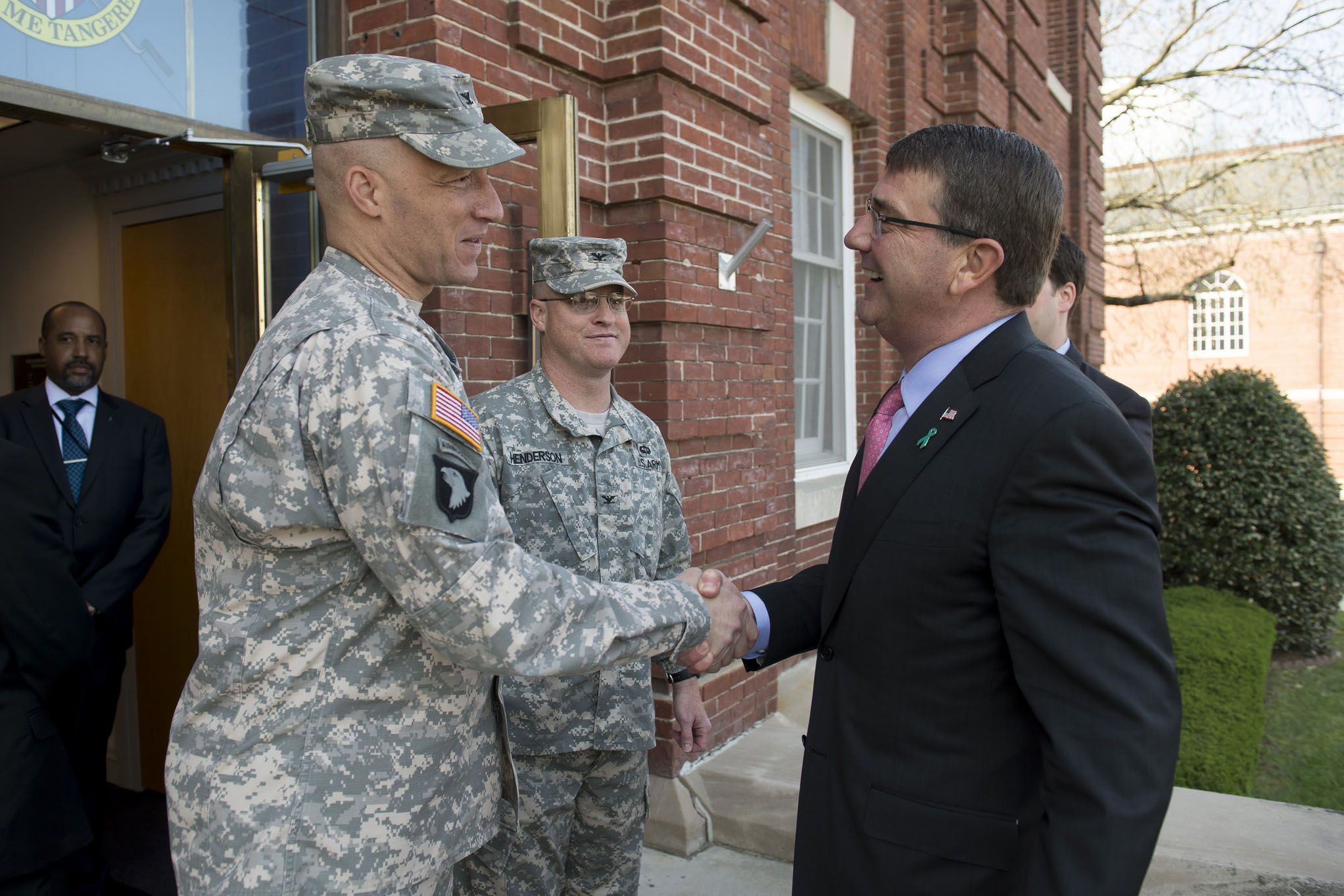 Defense Secretary Ash Carter, right, exchanges greetings with Army Col ...