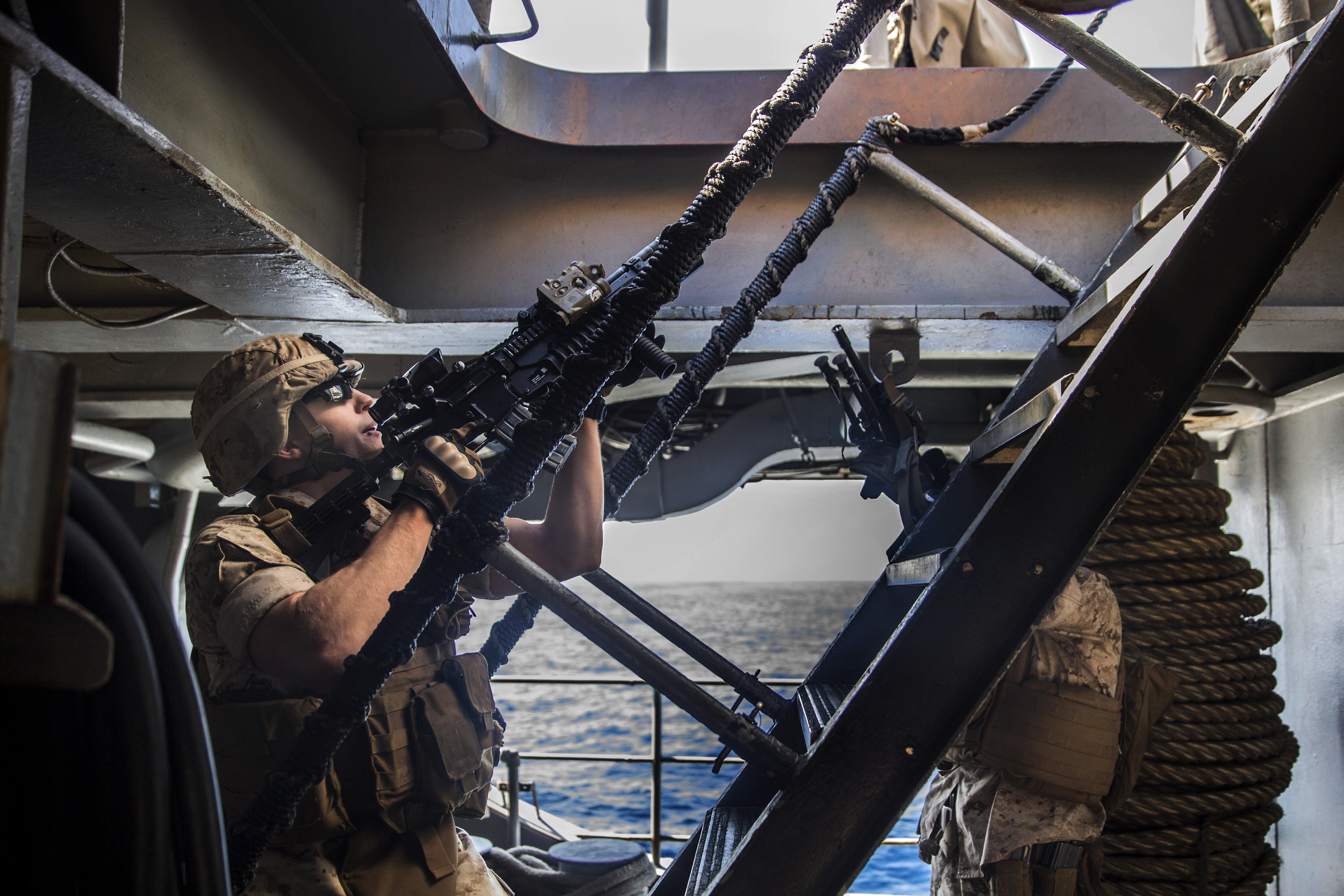 Marine Corps Cpl. Brian Dodman clears a ladder well while participating ...