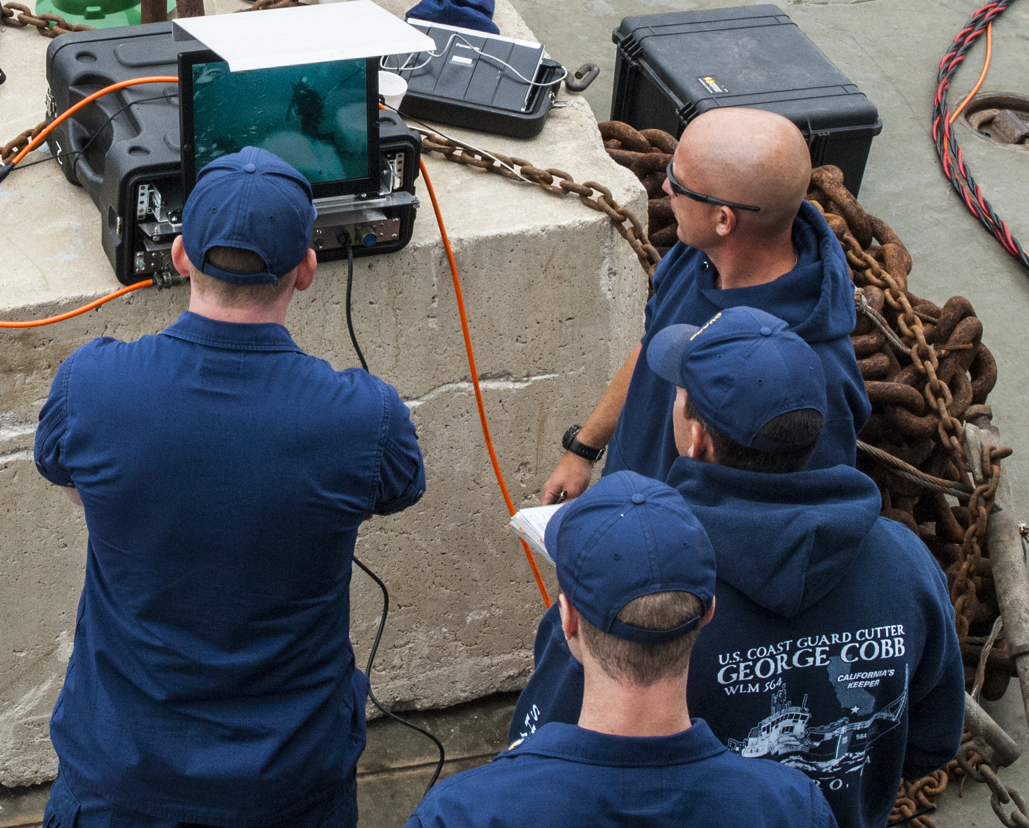 Coast Guardsmen assigned to the Coast Guard cutter George Cobb watch a ...