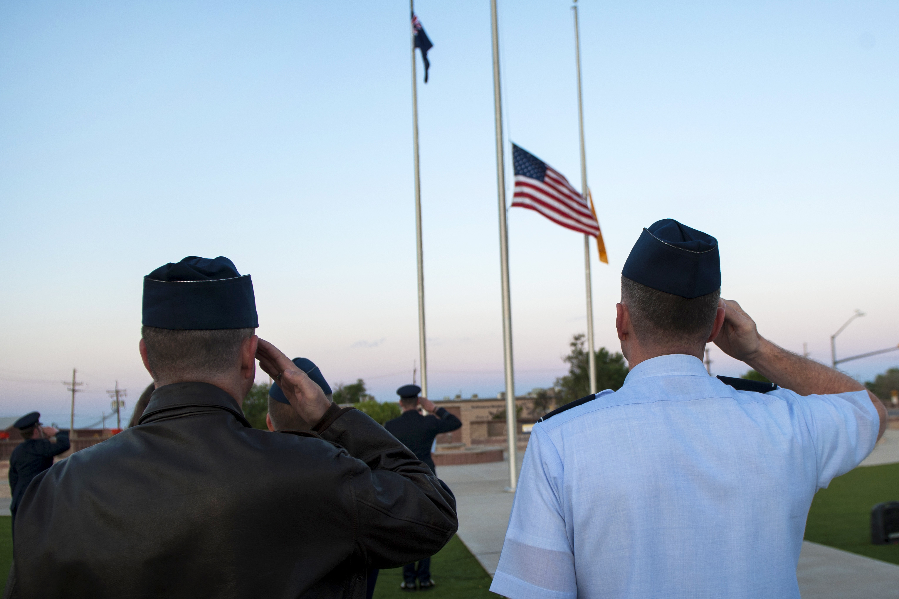 U.S. Air Force airmen salute as the Australian flag is raised during ...