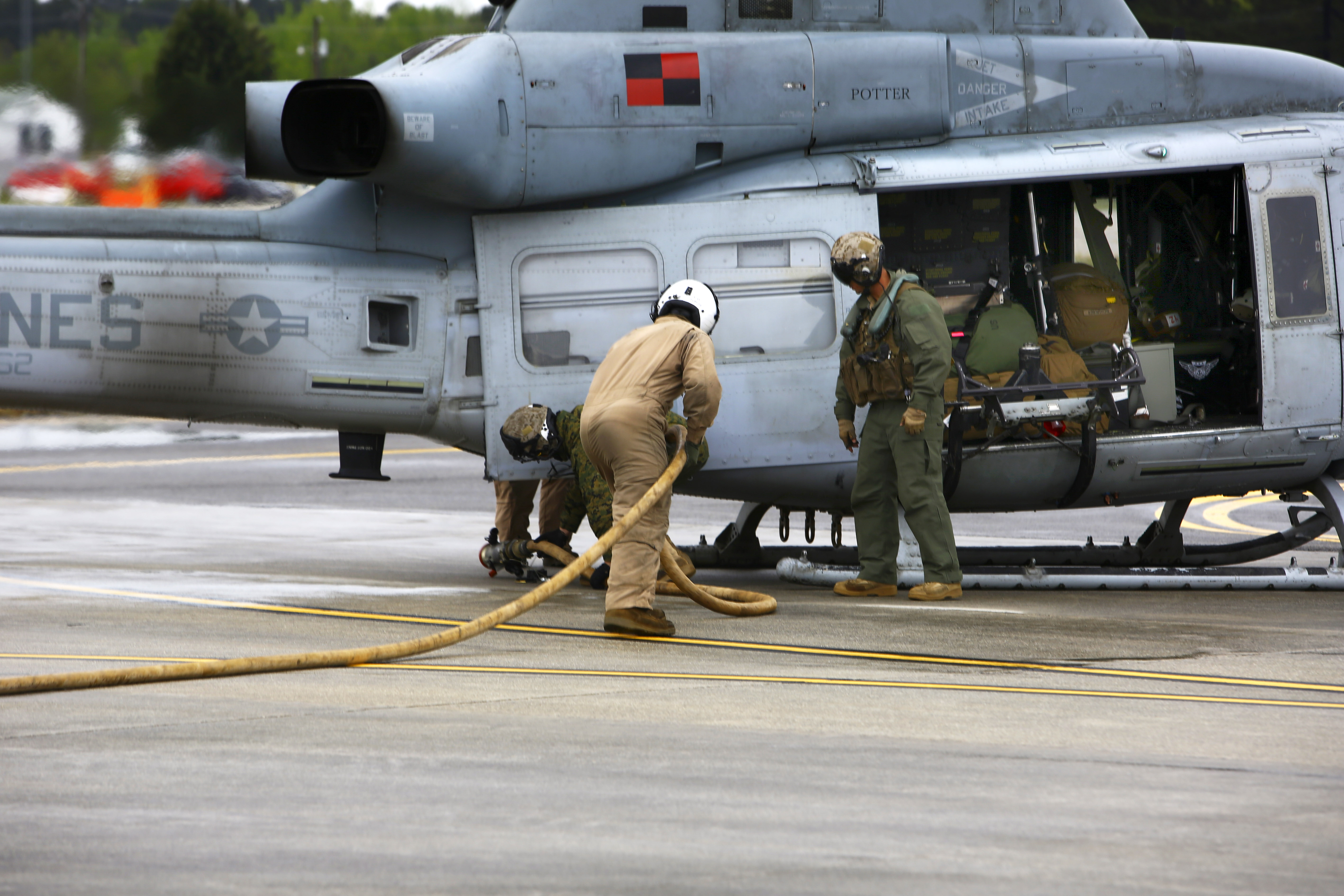 U.S. Marines prepare to refuel an UH-1Y Venom helicopter as part of air ...
