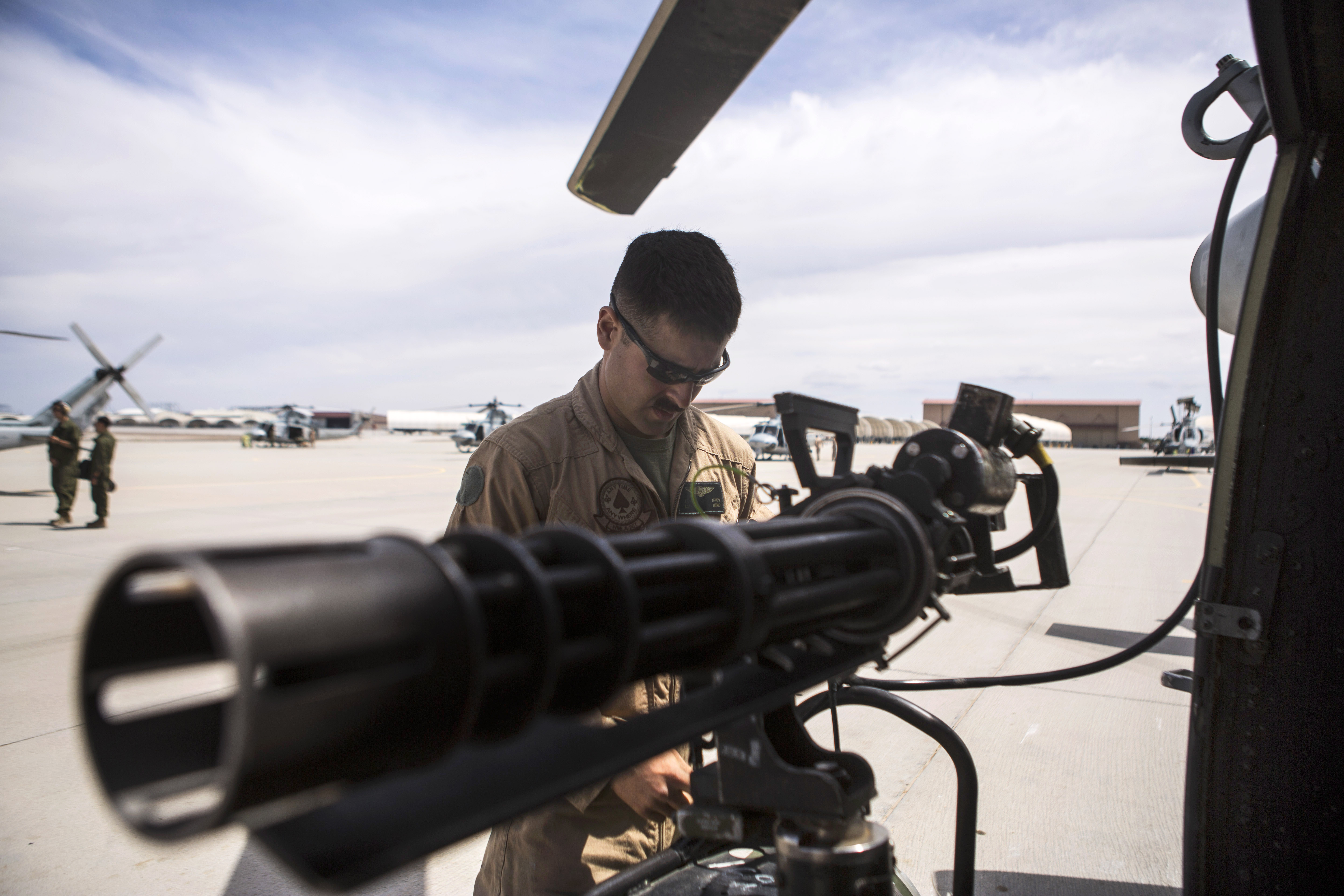 U.S. Marine Corps Sgt. Jessie T. James inspects a mini-gun before Final ...