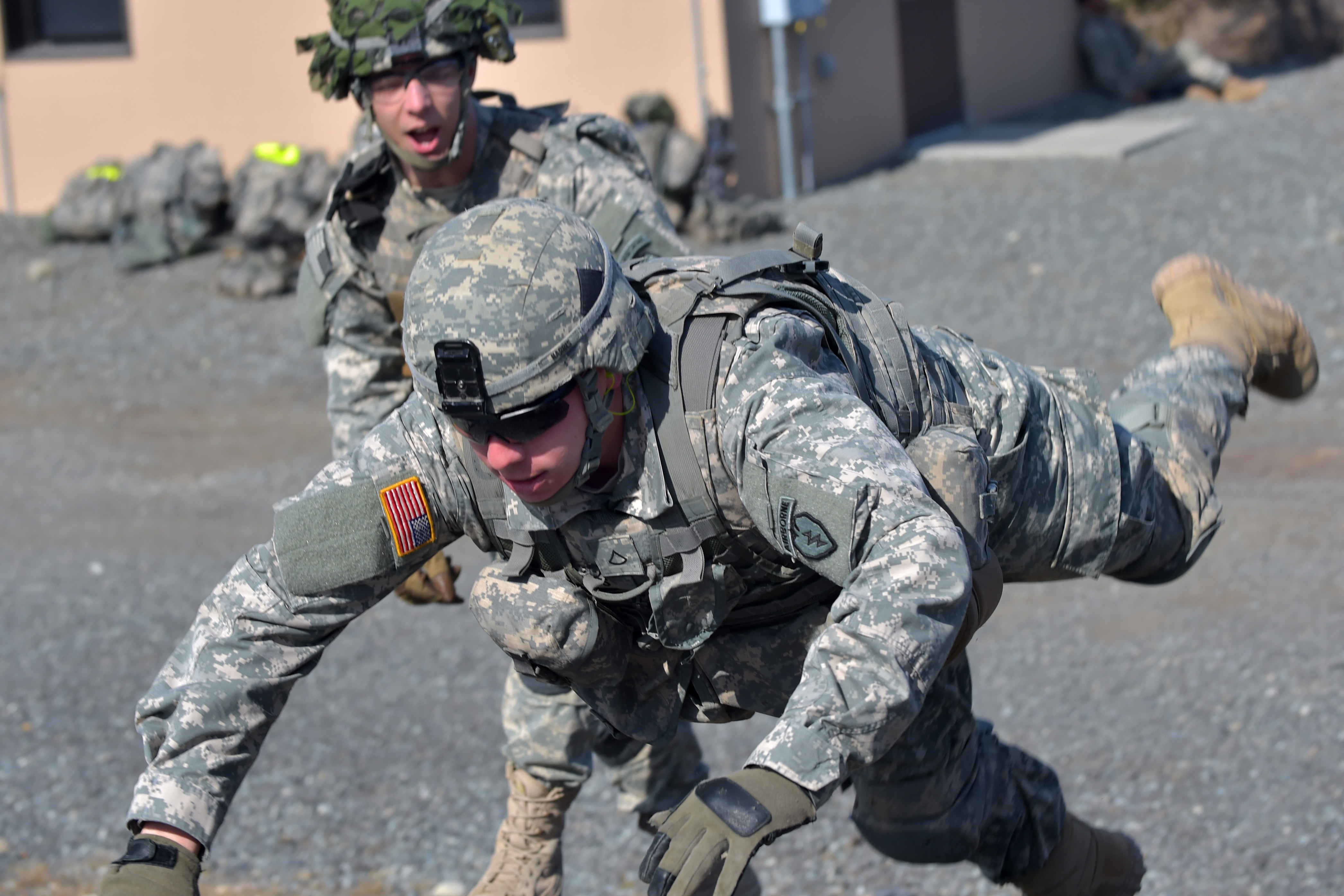 Army Pfc. Tyler Harris dives into the prone position as he performs a ...