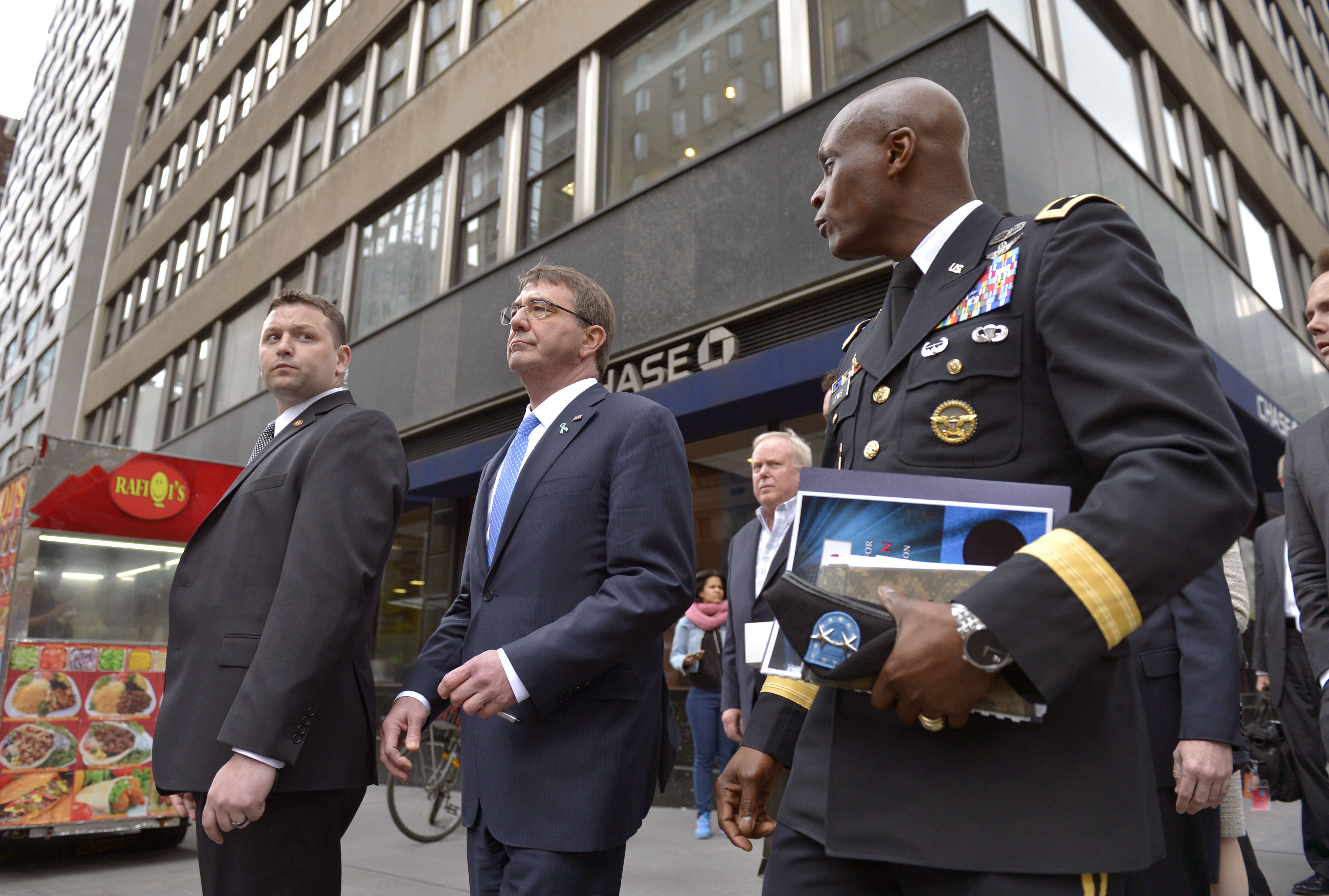 Defense Secretary Ash Carter, center, walks with Maj. Gen. Ronald F ...