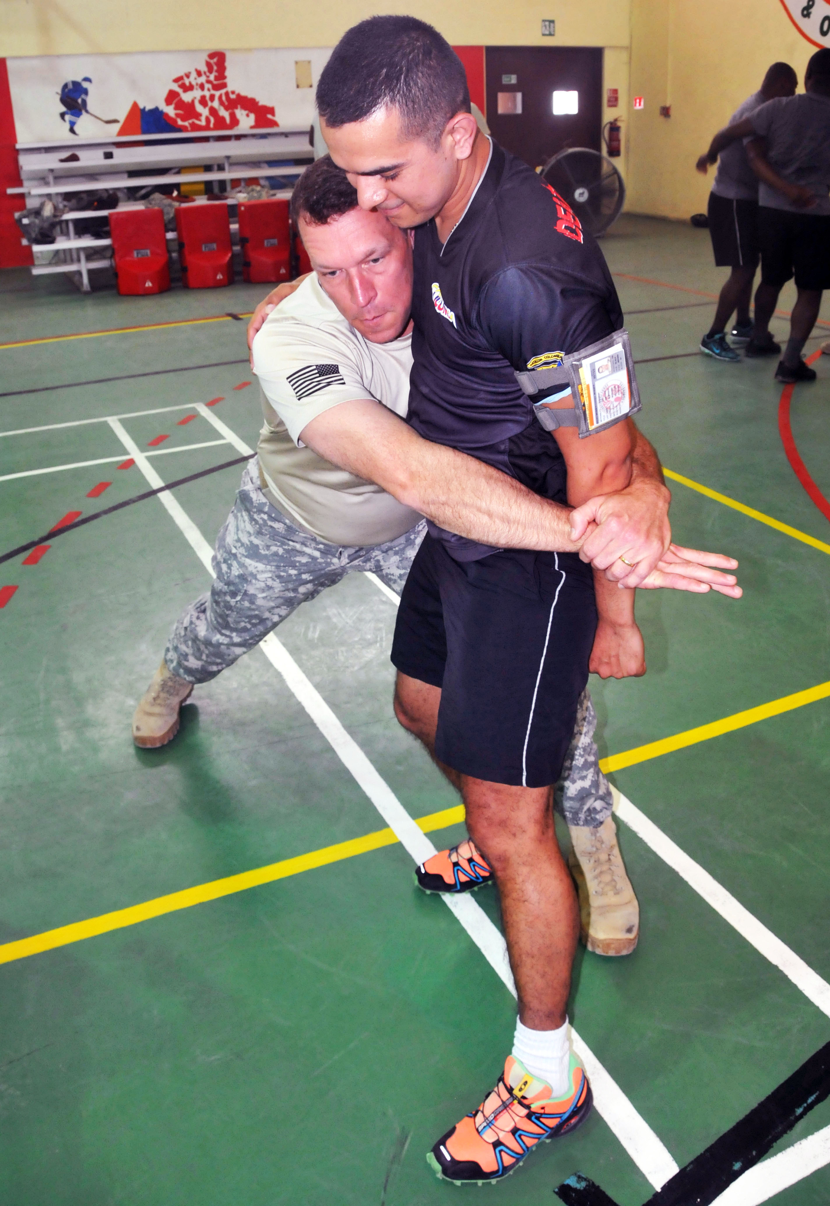 U.S. Army Col. Clark Lindner teaches takedown techniques to a soldier ...