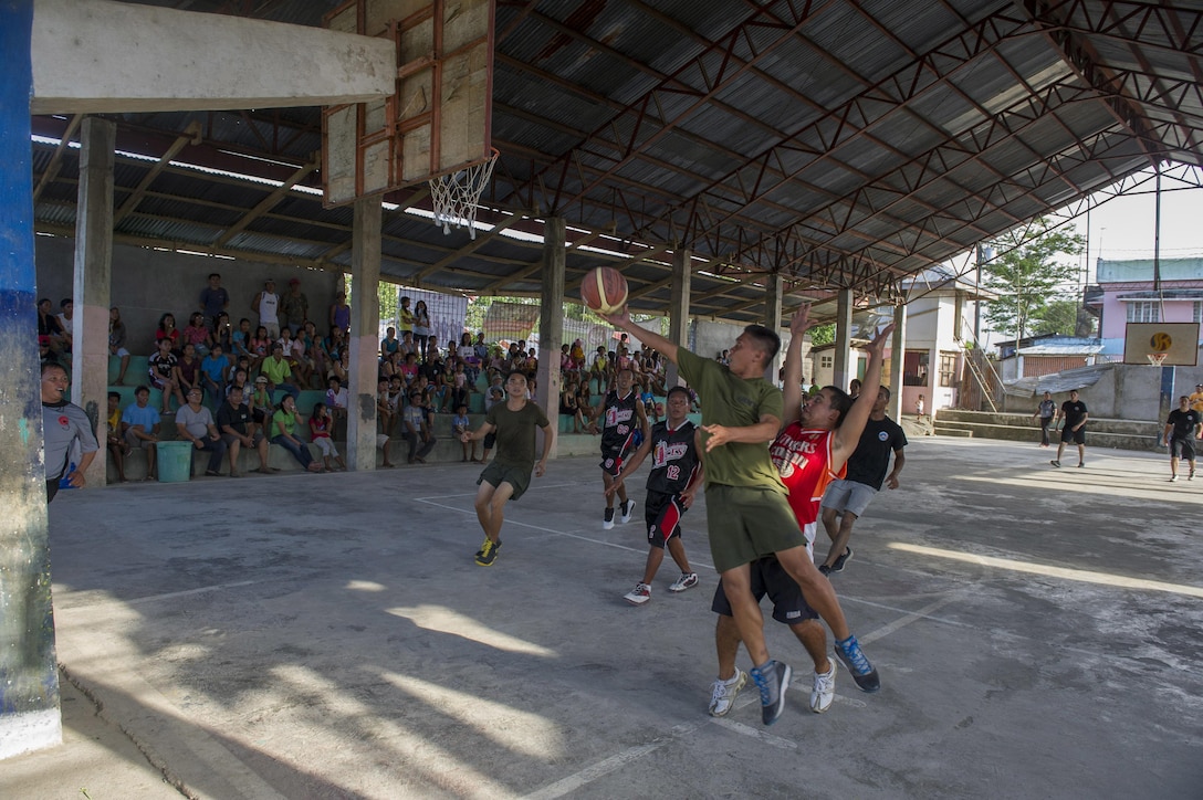 Panay CJCMOTF plays basketball in Taft Barangay during Balikatan