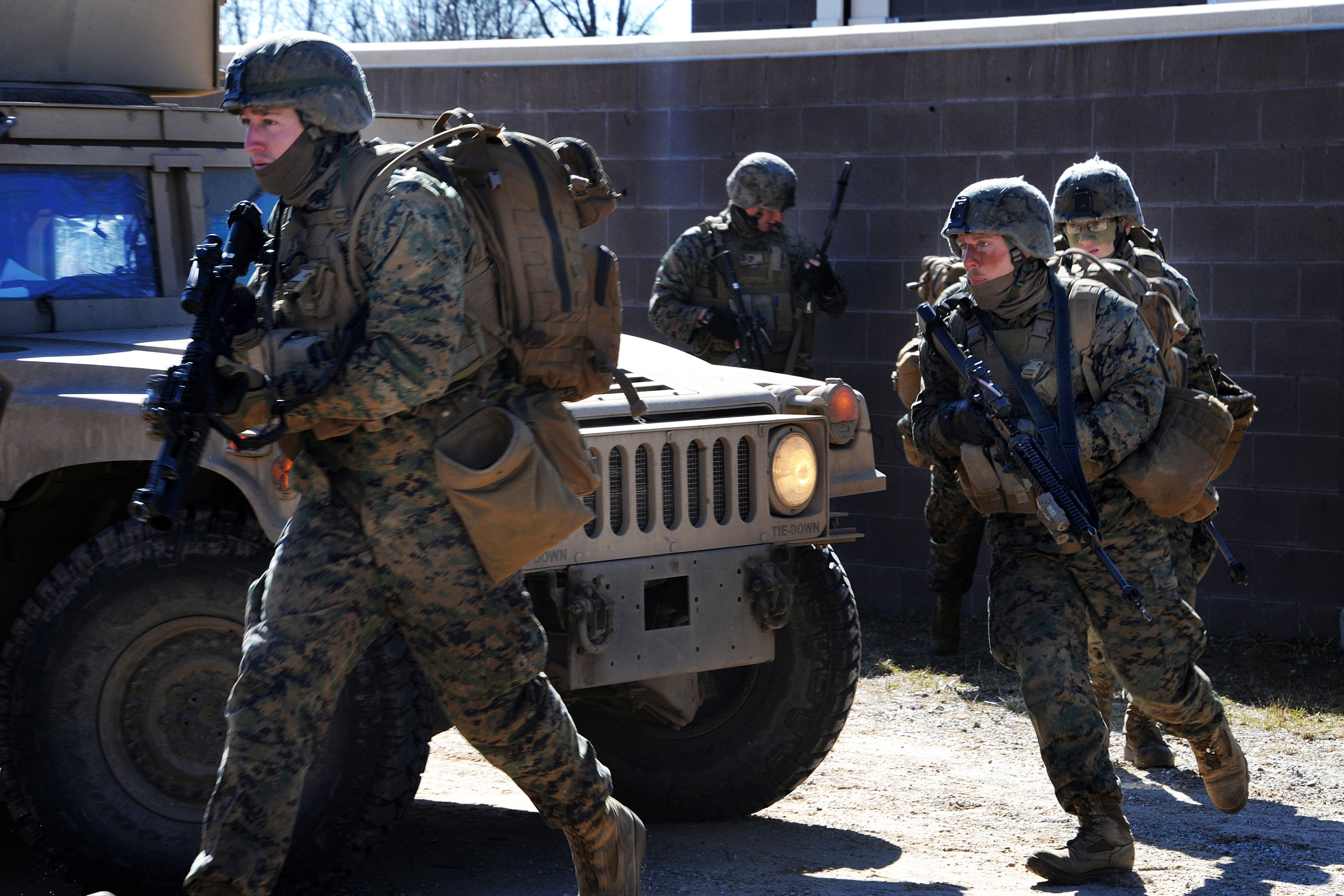 Marines provide security while advancing toward their objective during ...