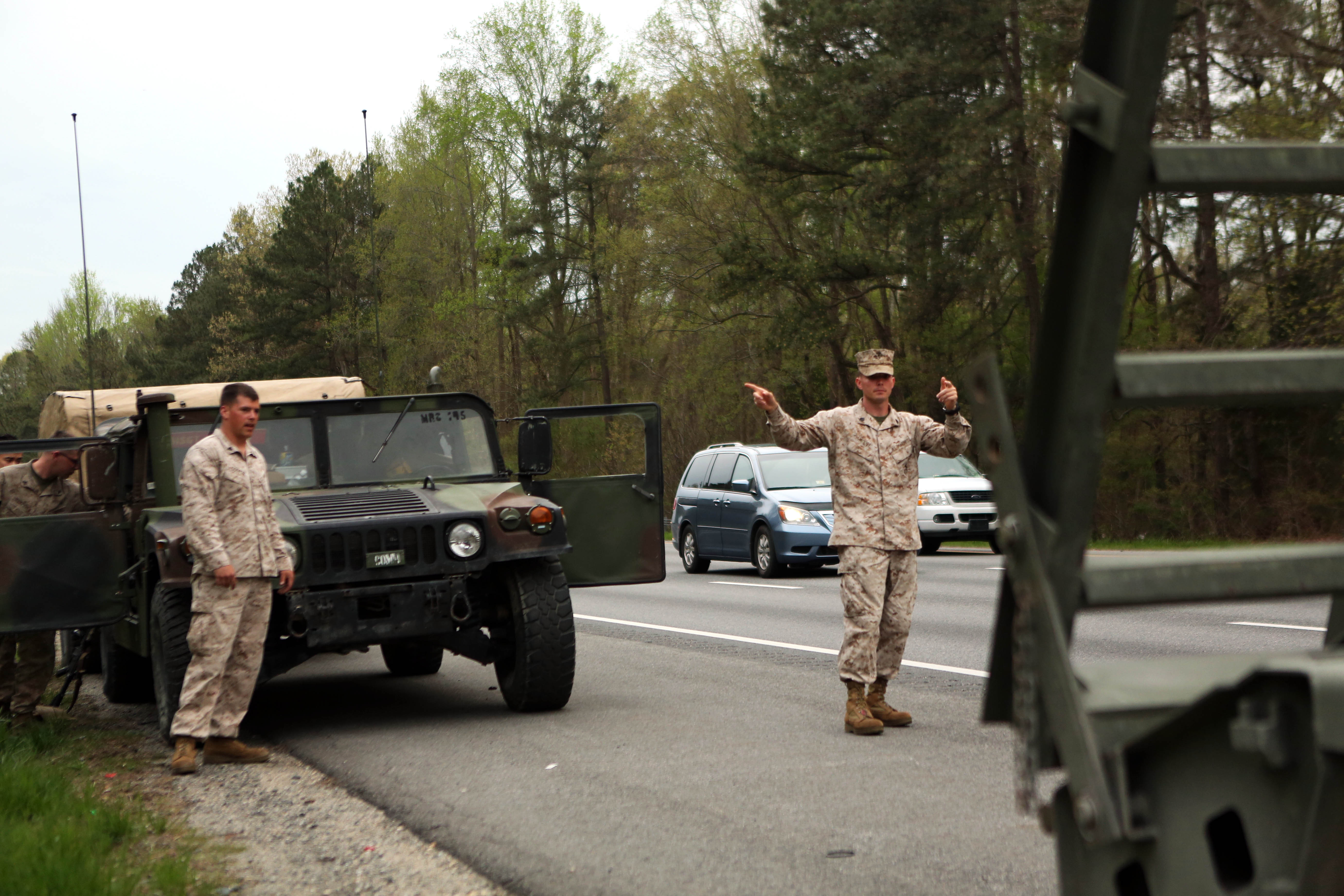 Marine Corps Staff Sgt. Michael Moore, right, ground guides an MKR16 ...